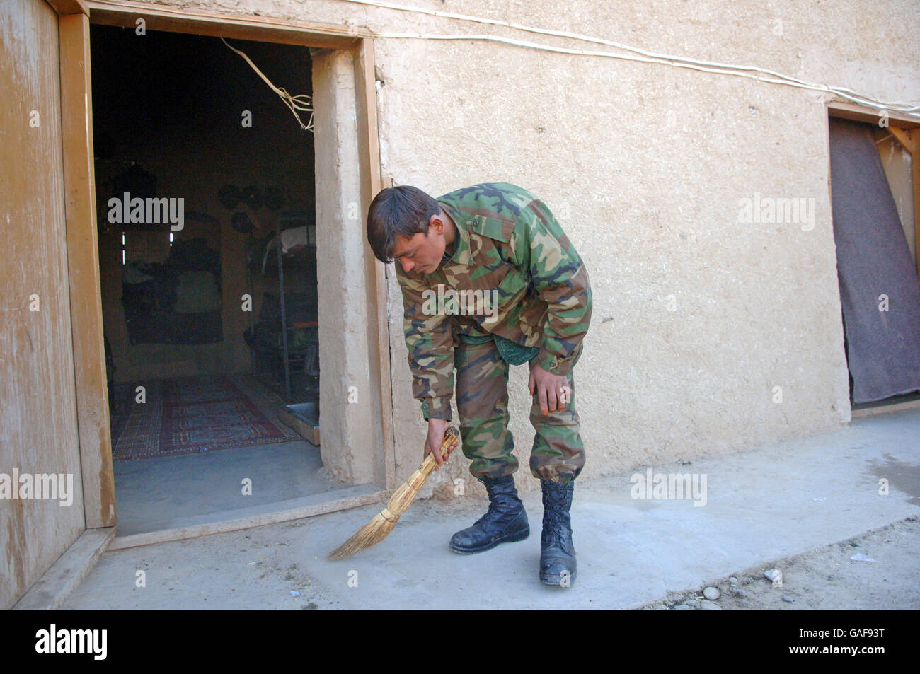 A Afghanistan National Army soldier cleans at the National Army's Camp ...
