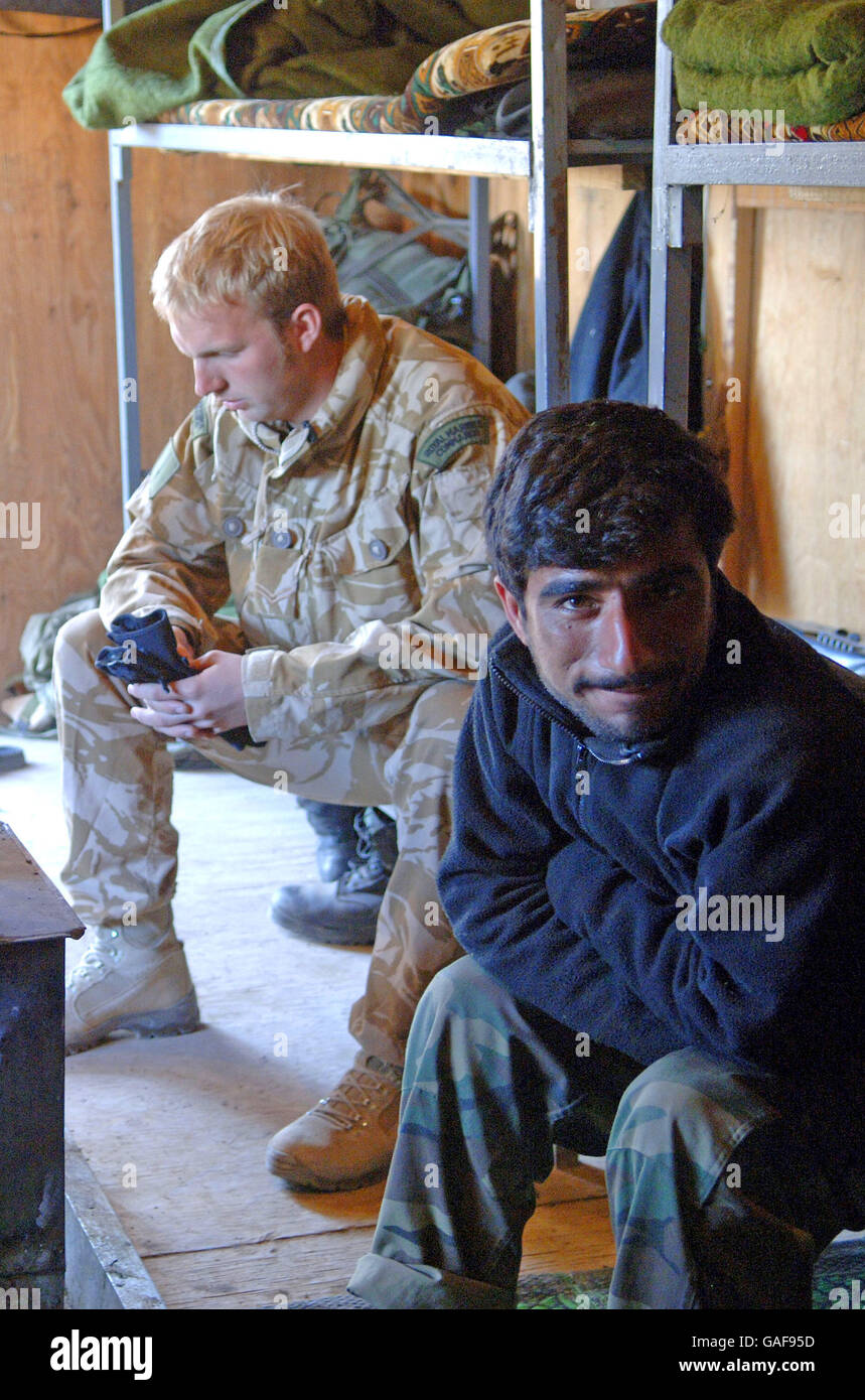 A Royal Marine Commando sits down with a Afghanistan National Army ...