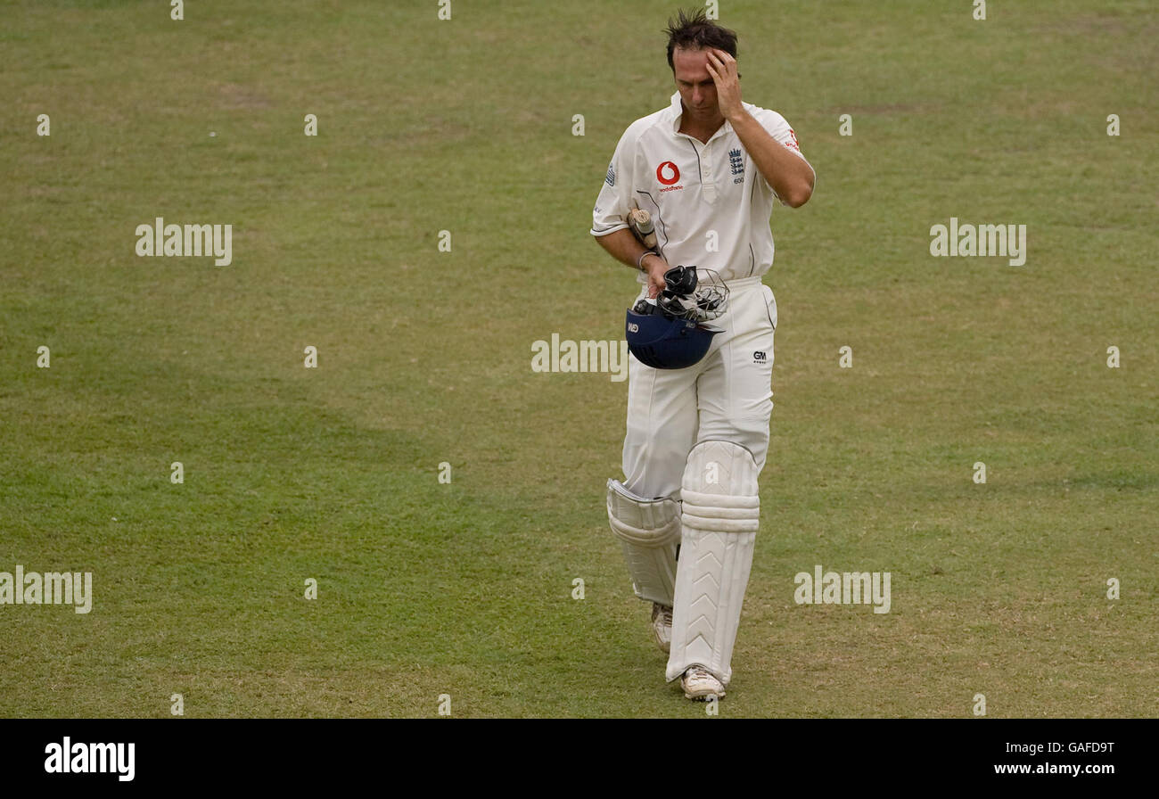 England captain Michael Vaughan leaves the field after bad light stops ...