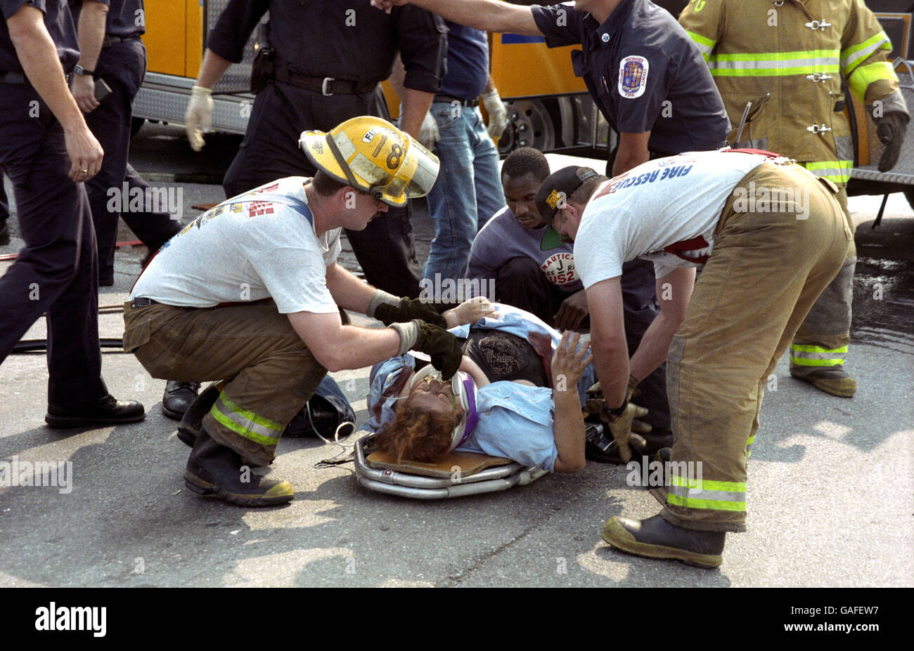 Firefighters work on a woman injured in a car accident in Glendale, Md ...