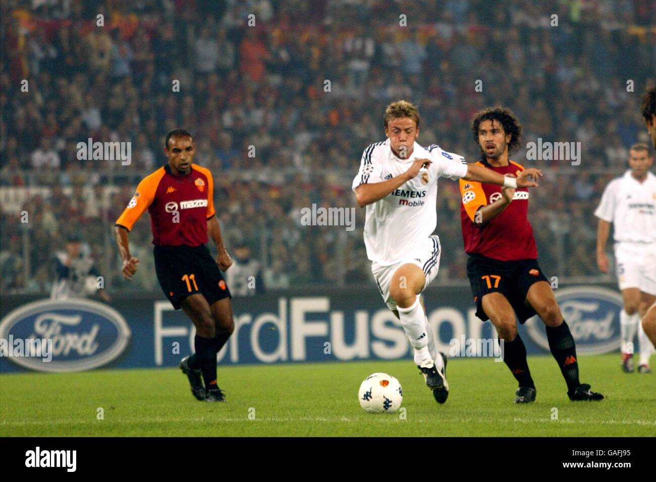 Real madrids guti breaks passed romas damiano tommasi r hi-res stock ...