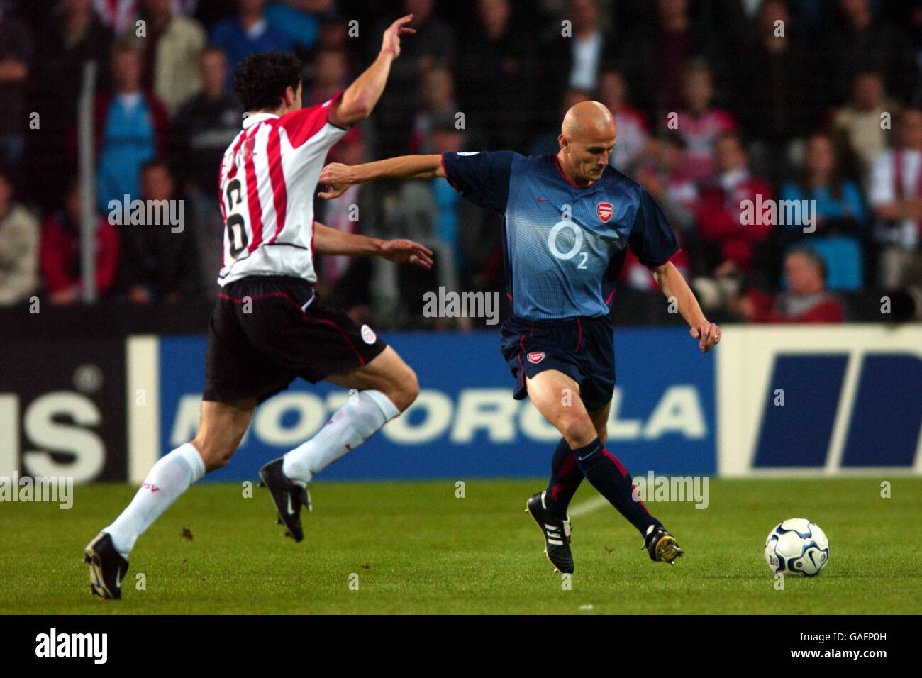 Arsenal's Pascal Cygan (r) clears the ball from PSV Eindhoven's Mark ...