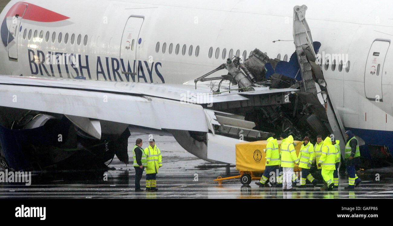 Workers remove the emergency slides from the British Airways 777 that ...