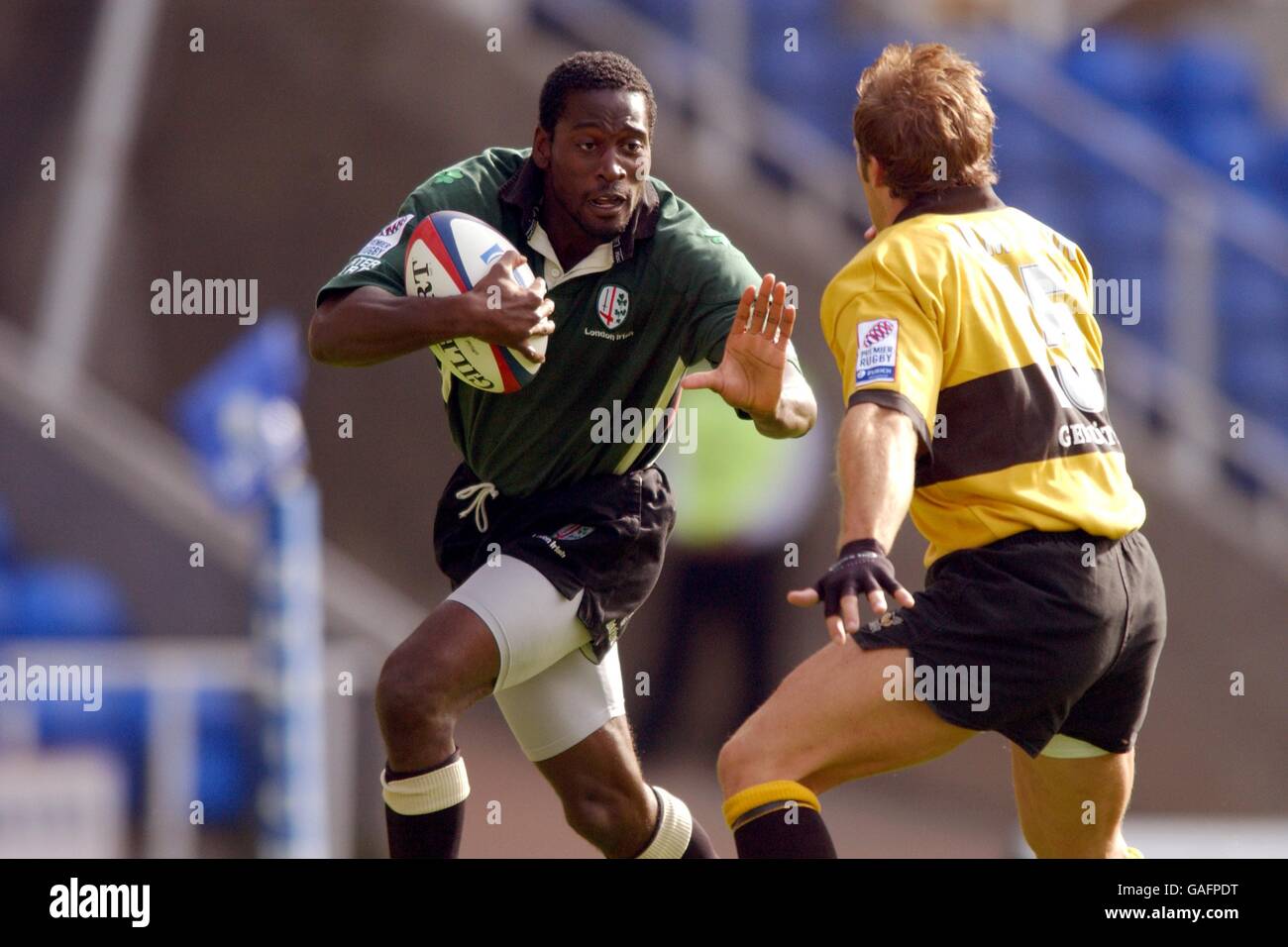 London Irish's Paul Sackey holds off a challenge from London Wasps ...