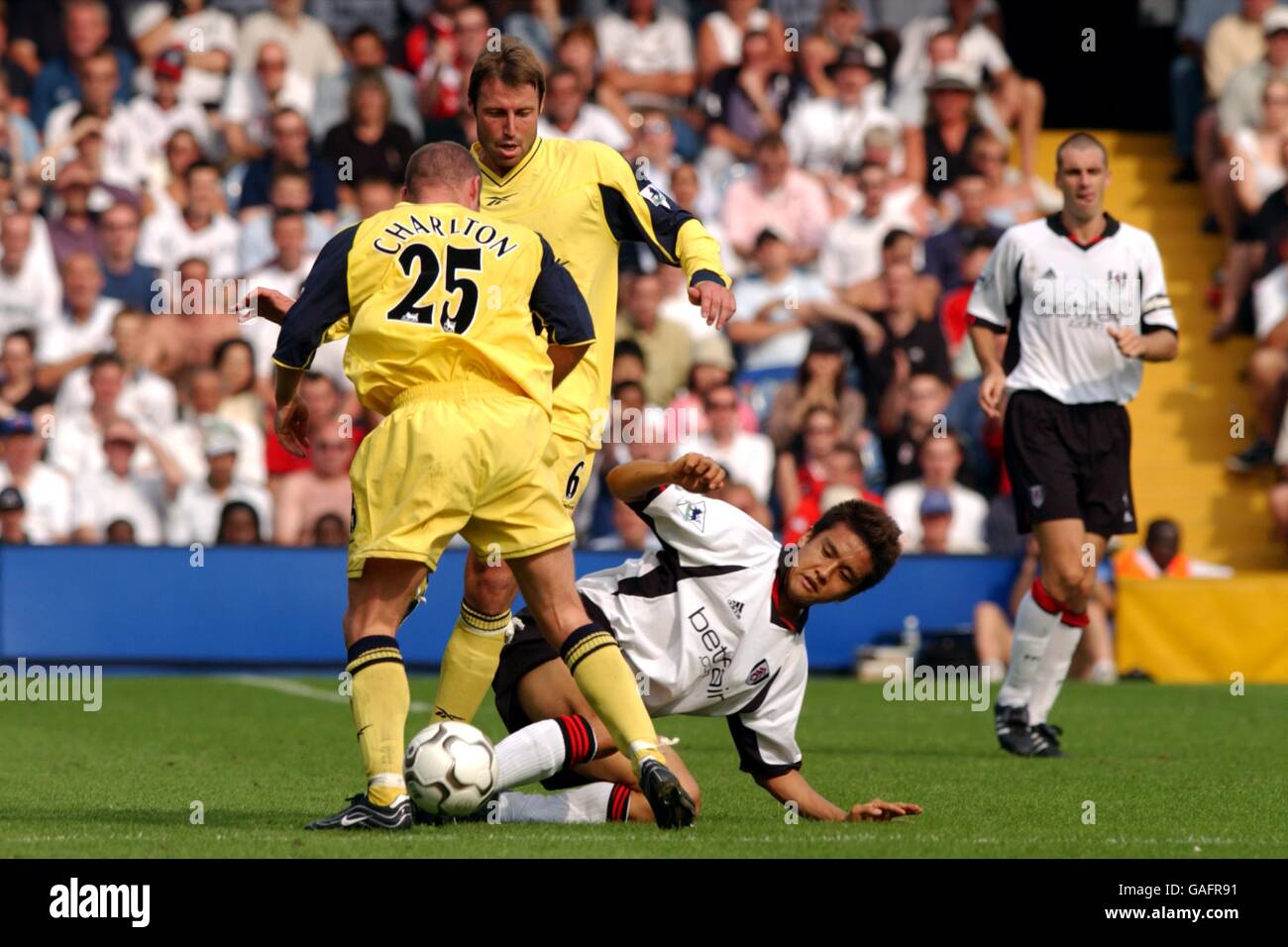 Fulham's Junichi Inamoto (floor) and Bolton Wanderers' Simon Charlton ...