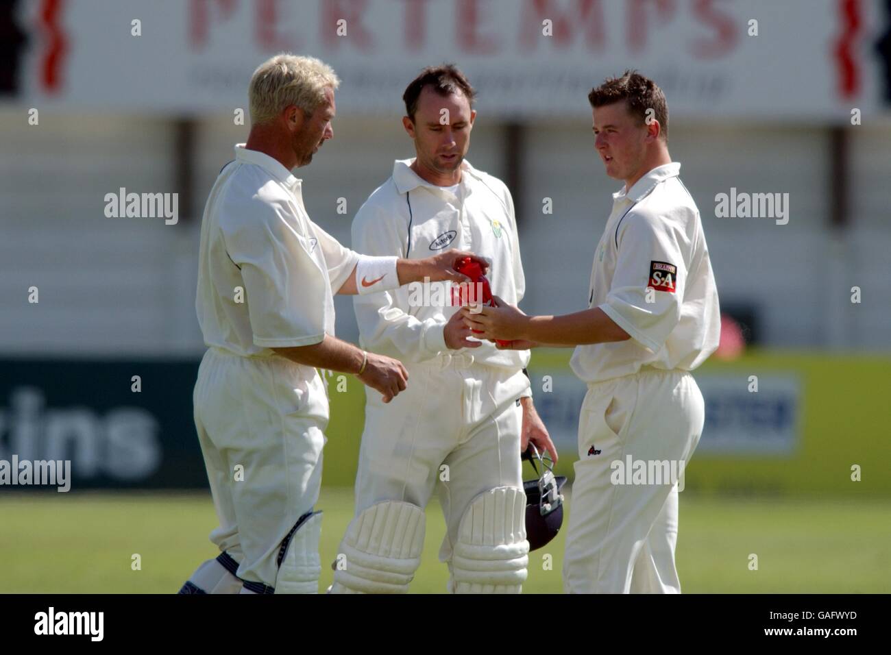 Glamorgan's Matthew Maynard (L) and Adrian Dale (C) are given ...