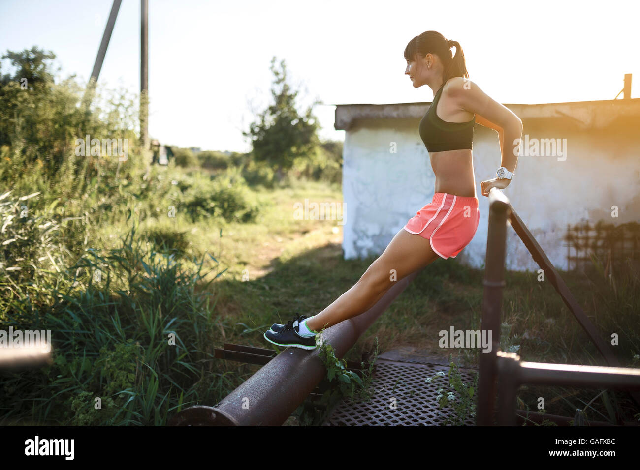 athletic woman doing push-ups on the nature Stock Photo - Alamy