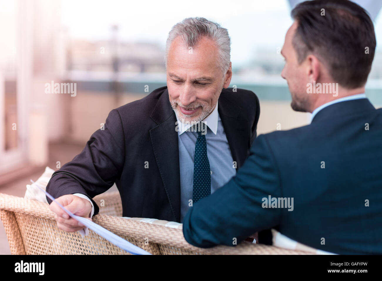 Positive colleagues working with papers Stock Photo - Alamy