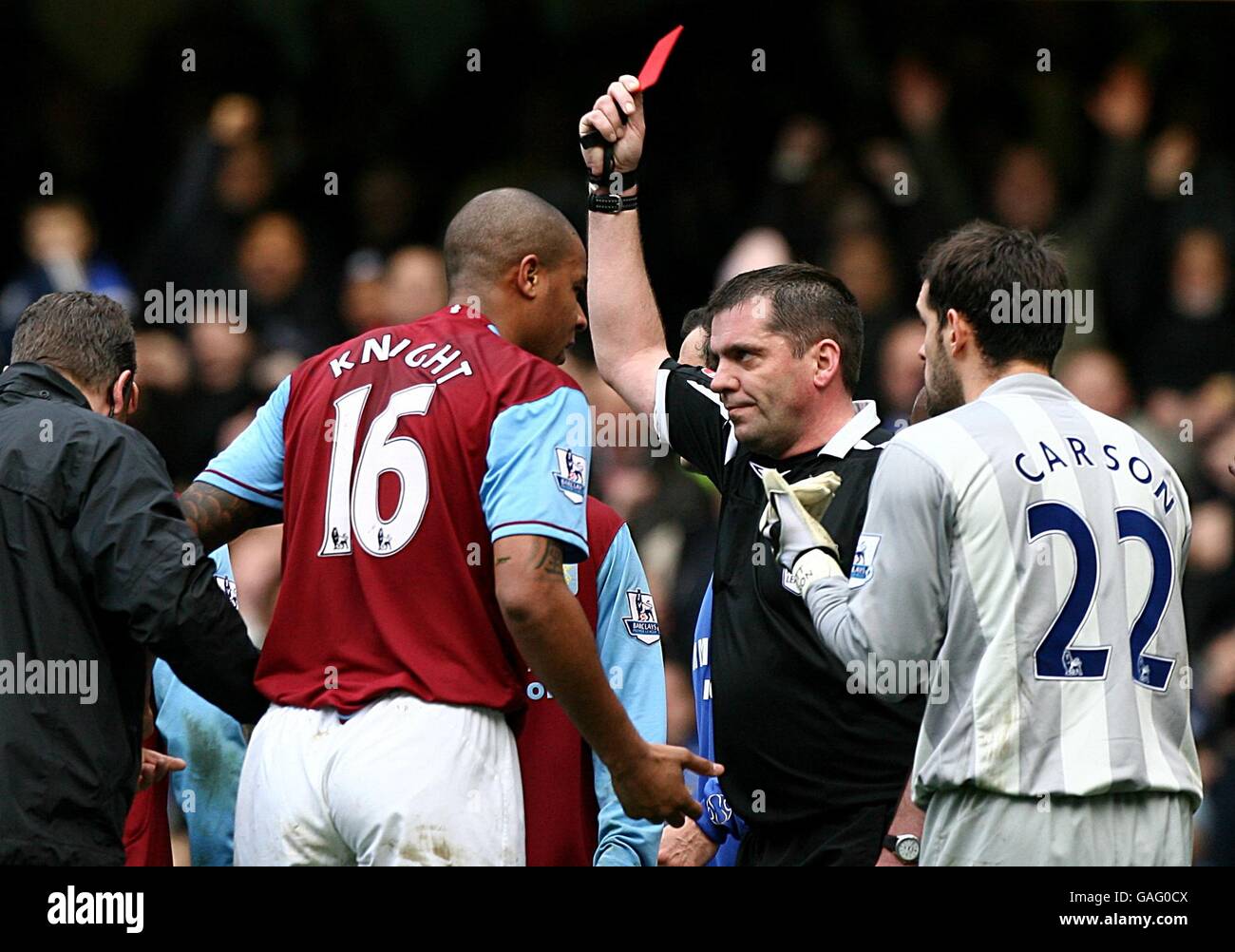 Referee Phil Dowd shows Aston Villa's Zat Knight the red card for a professional foul on Chelsea ...