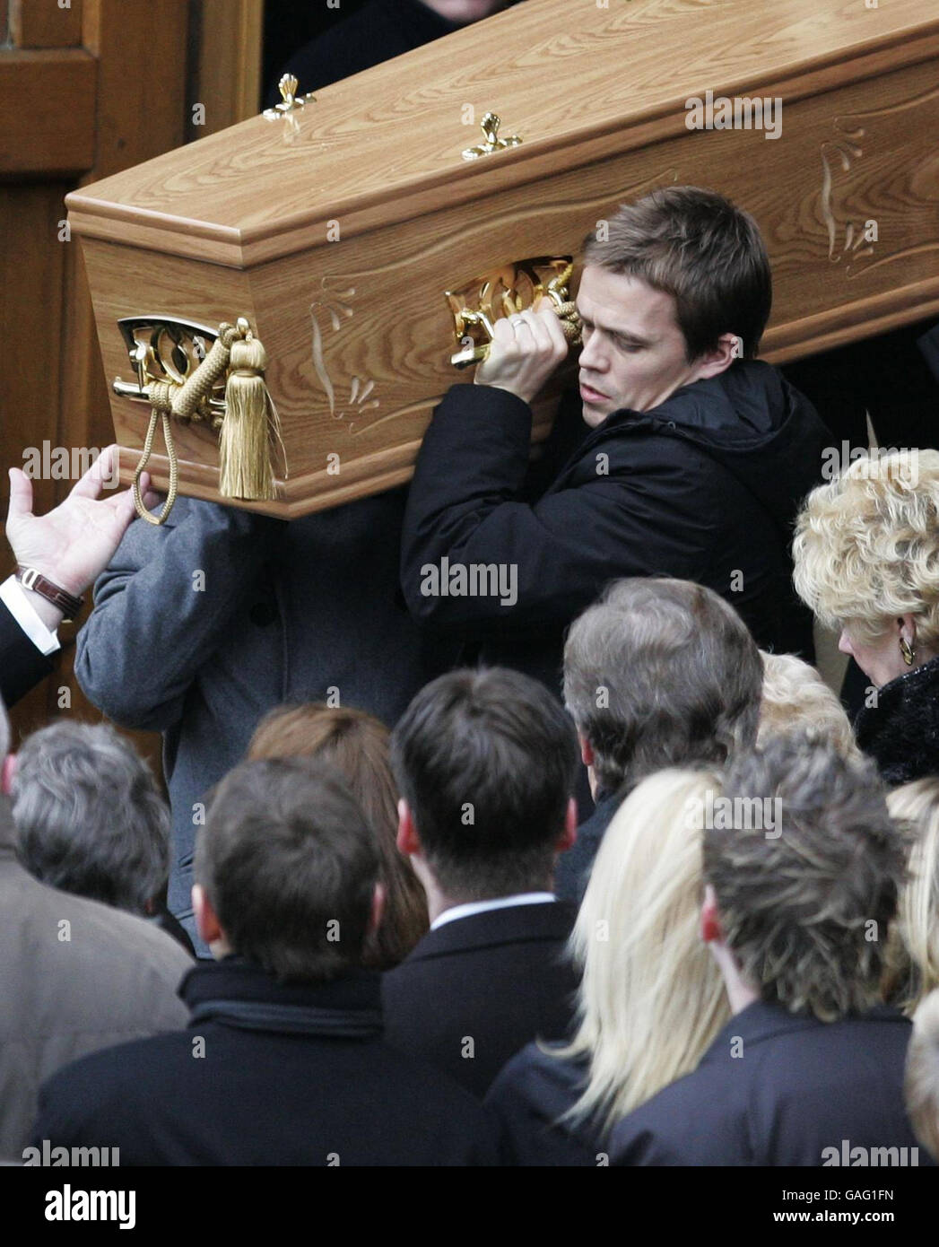 Former Celtic player Simon Donnelly carries the coffin of the ...
