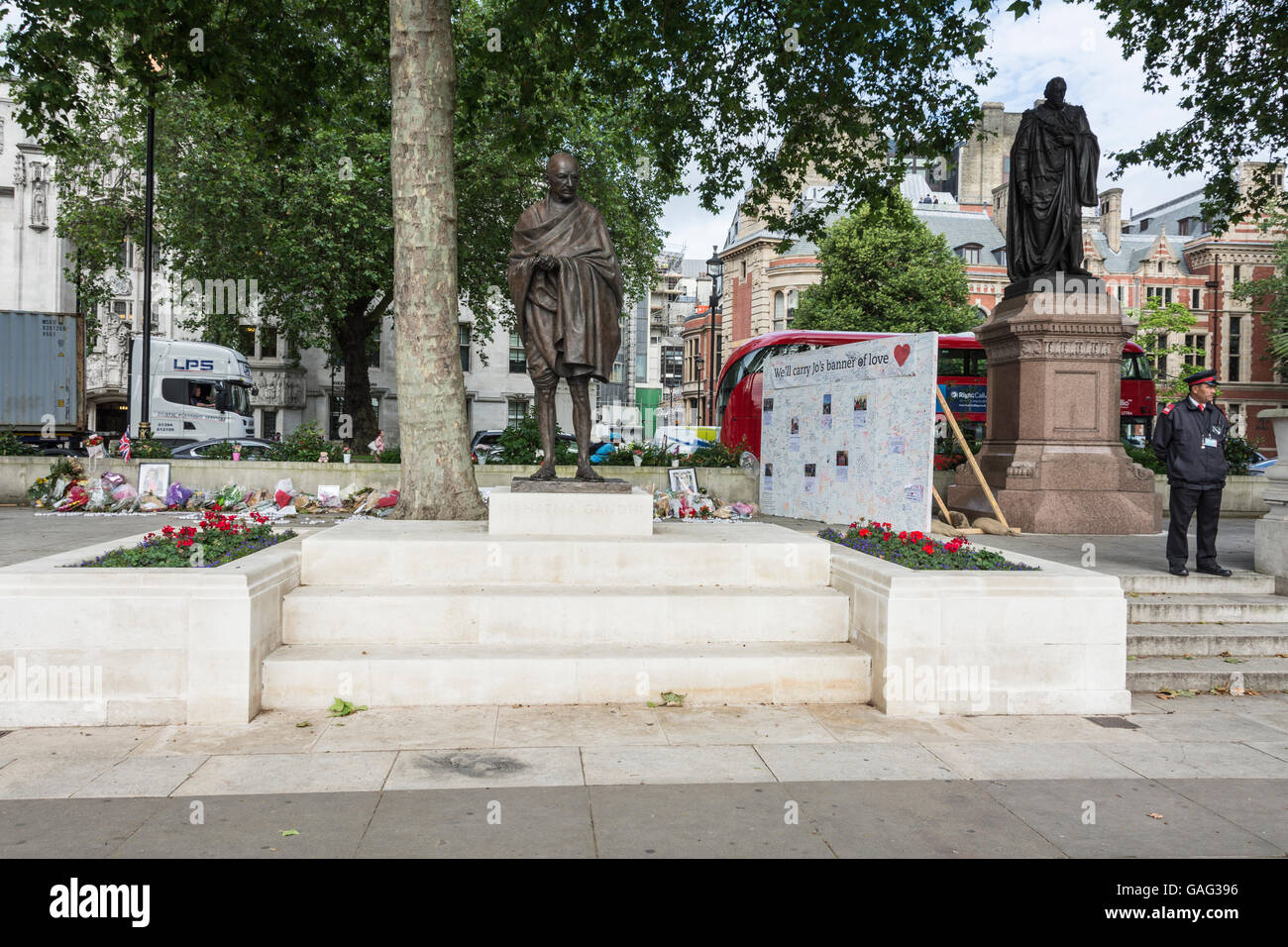 Floral tributes and mementos to the Labour MP Jo Cox behind the statue ...