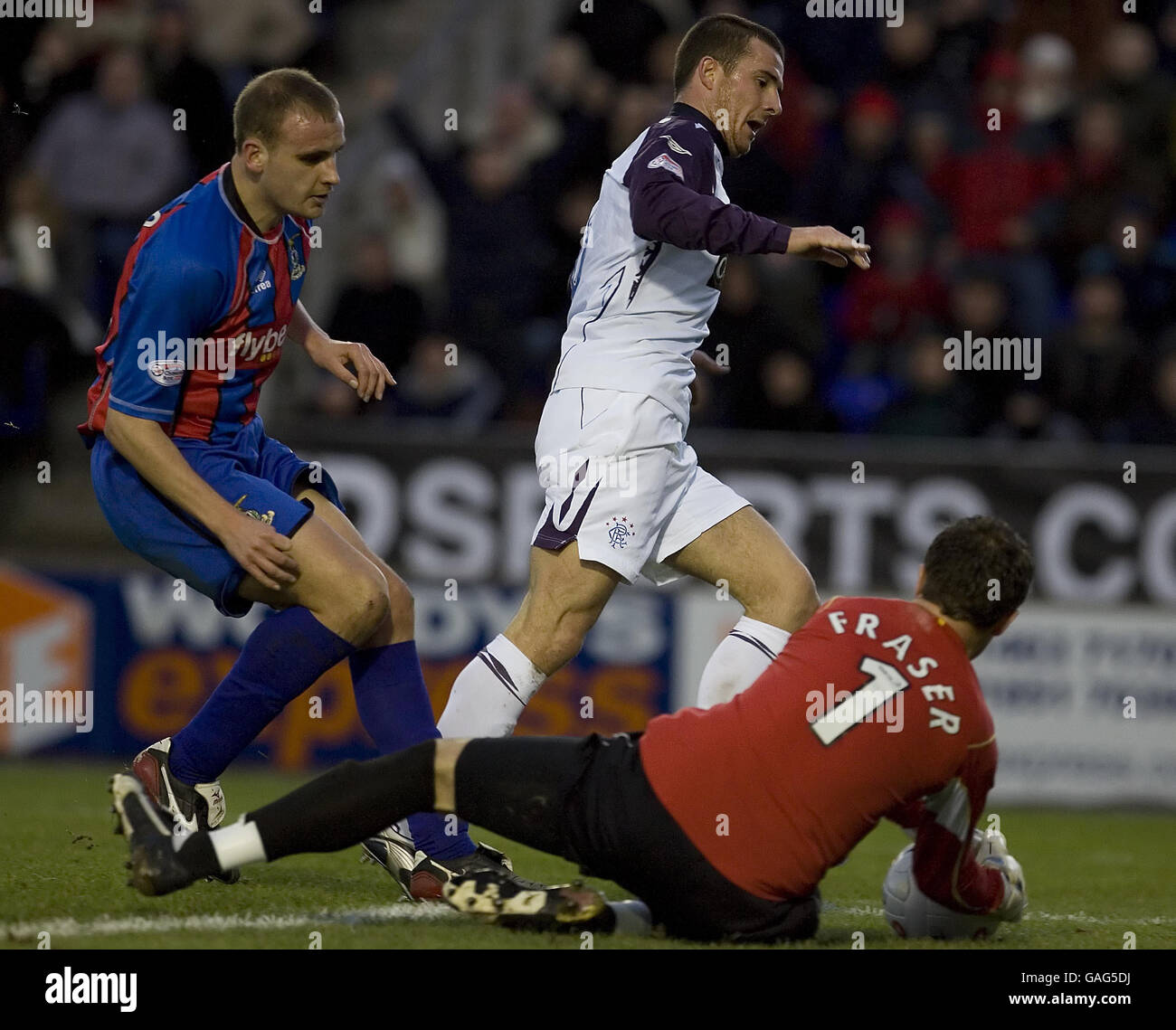 Inverness's Michael Fraser takes the ball away from the feet of Rangers ...