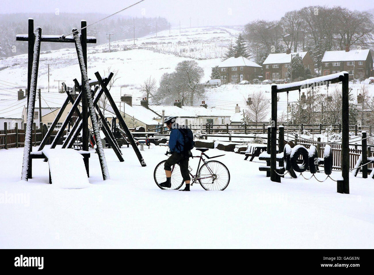 A cyclist pushes her bike through heavy snow in Nenthead on the ...