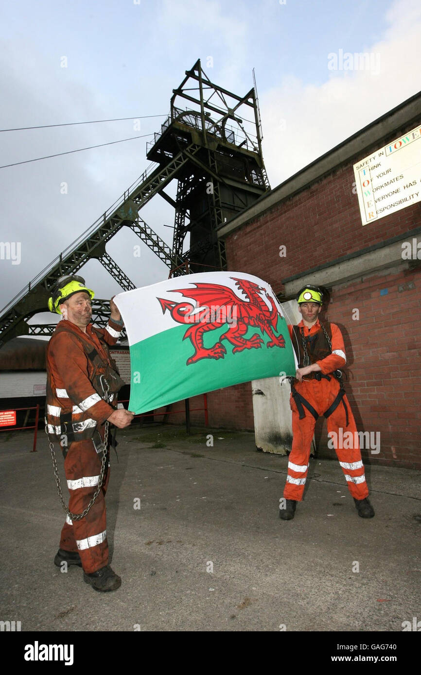 Miners Garry Cutland and Billy Teague loft the Welsh Flag as they ...