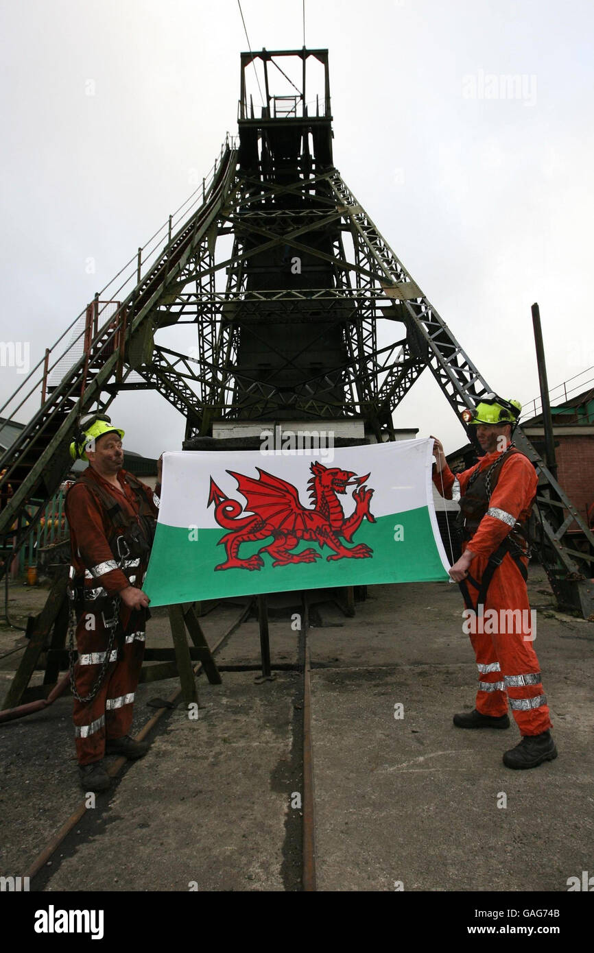 Miners Garry Cutland and Billy Teague loft the Welsh Flag as they ...