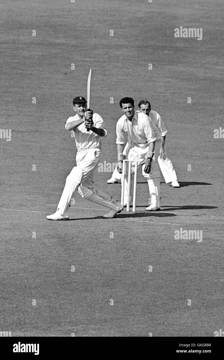 Surrey's Eric Bedser (l) lofts a ball from Middlesex's Fred Titmus (out ...