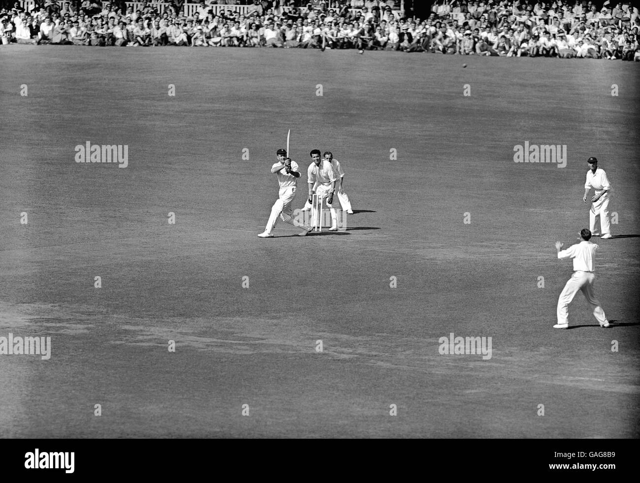 Surrey's Eric Bedser (l) lofts a ball from Middlesex's Fred Titmus (out ...