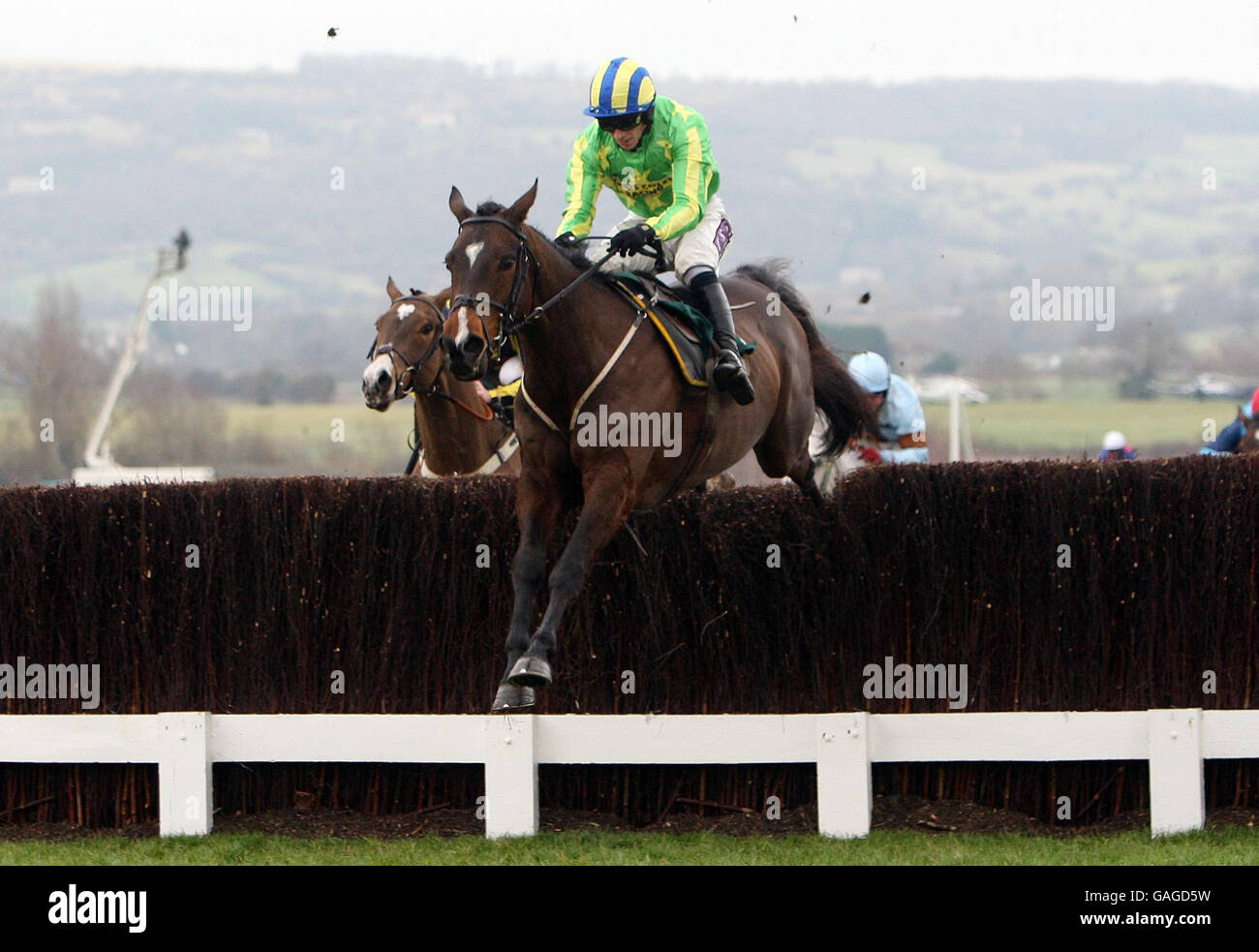 Irish Raptor and jockey Paddy Brennan jumps the last to go on and win ...