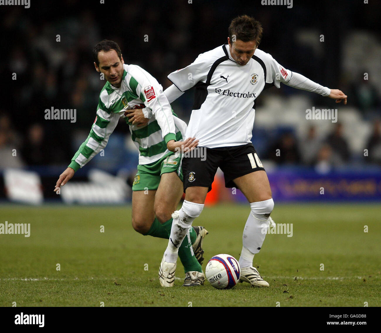 Darren Currie of Luton Town is challenged by Matt Rose of Yeovil Town ...