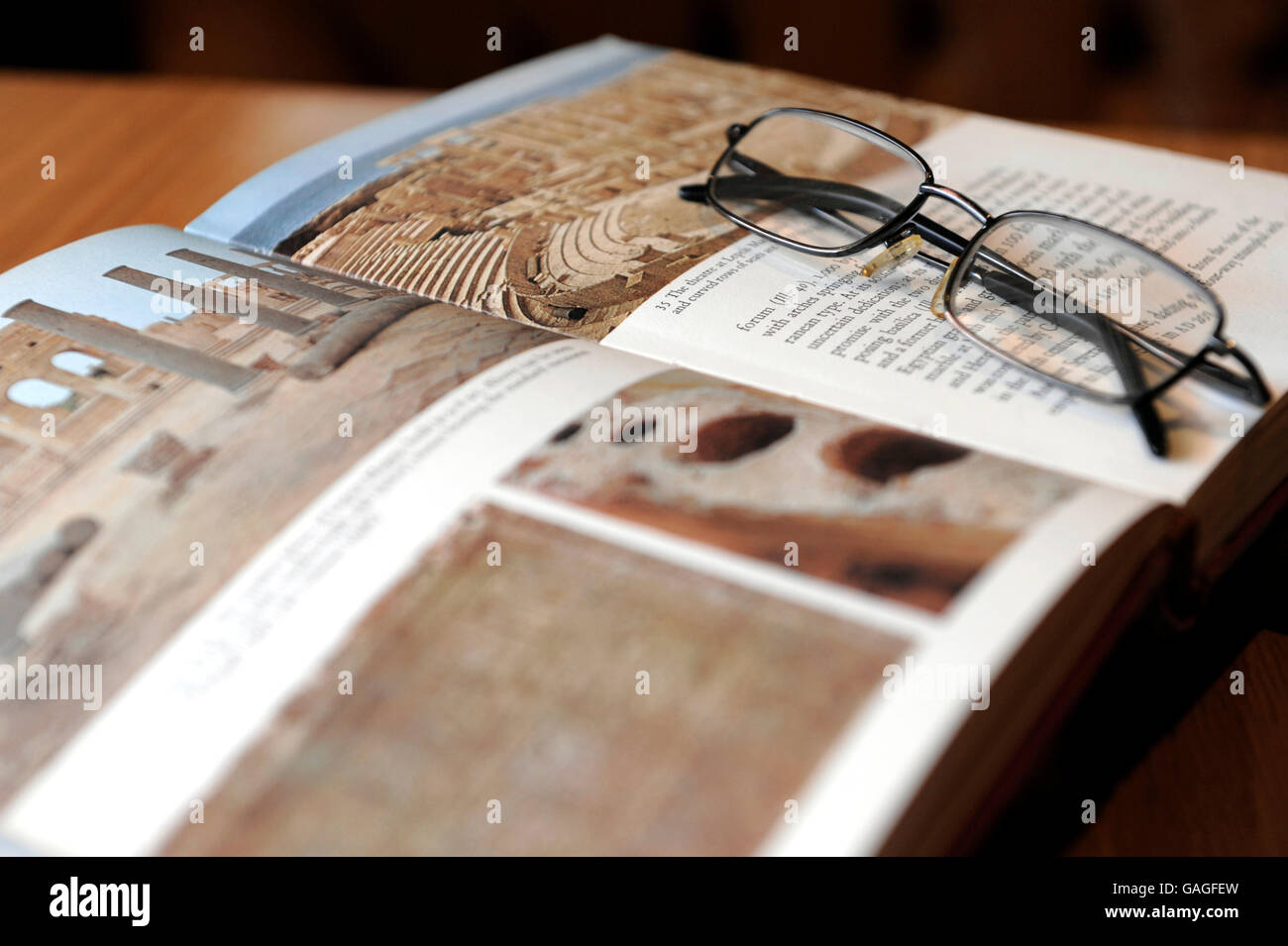 Reading glasses on top of book of antiquity Stock Photo - Alamy