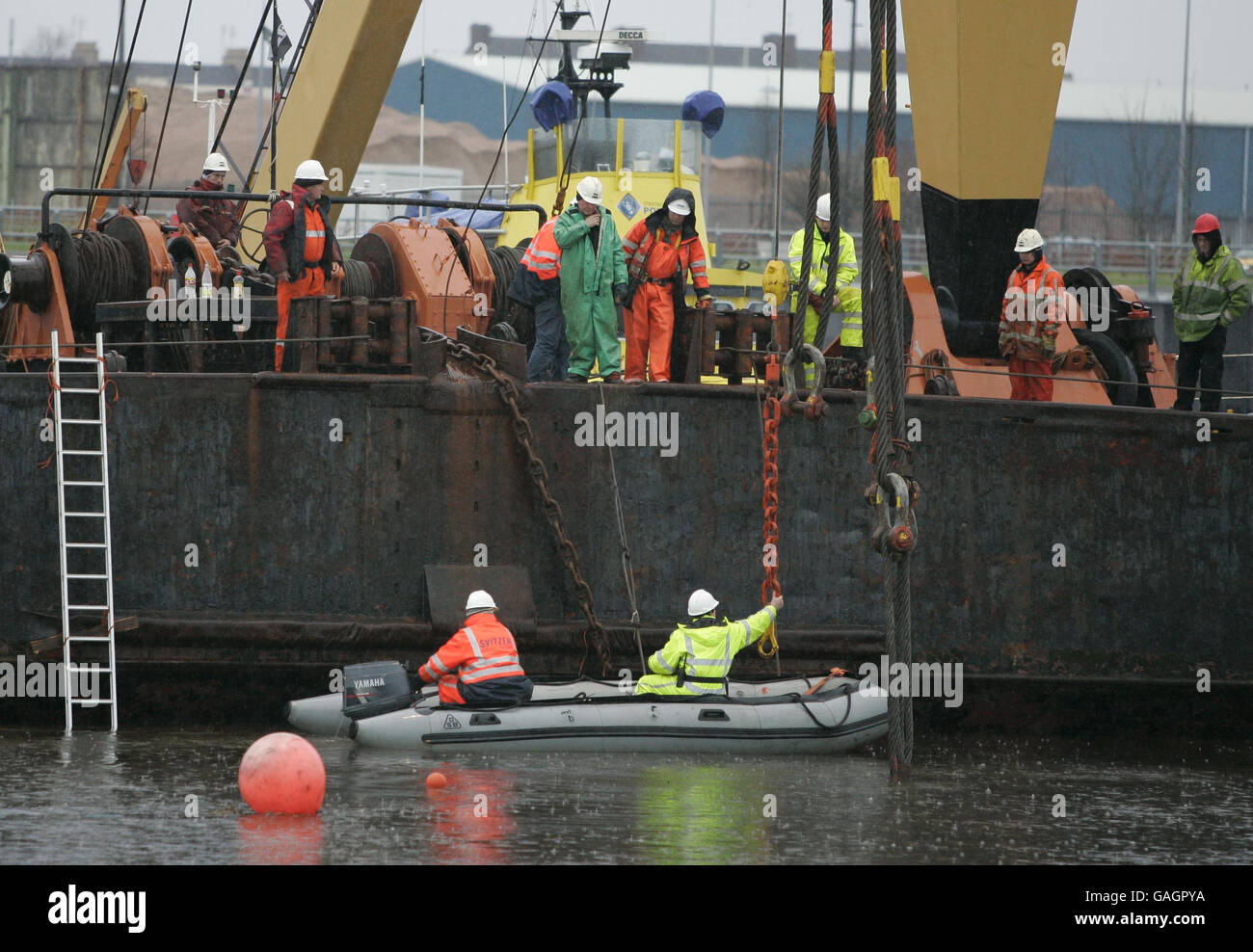 Workmen from the barge, GPS Atlas, which is capable of lifting 400 ...
