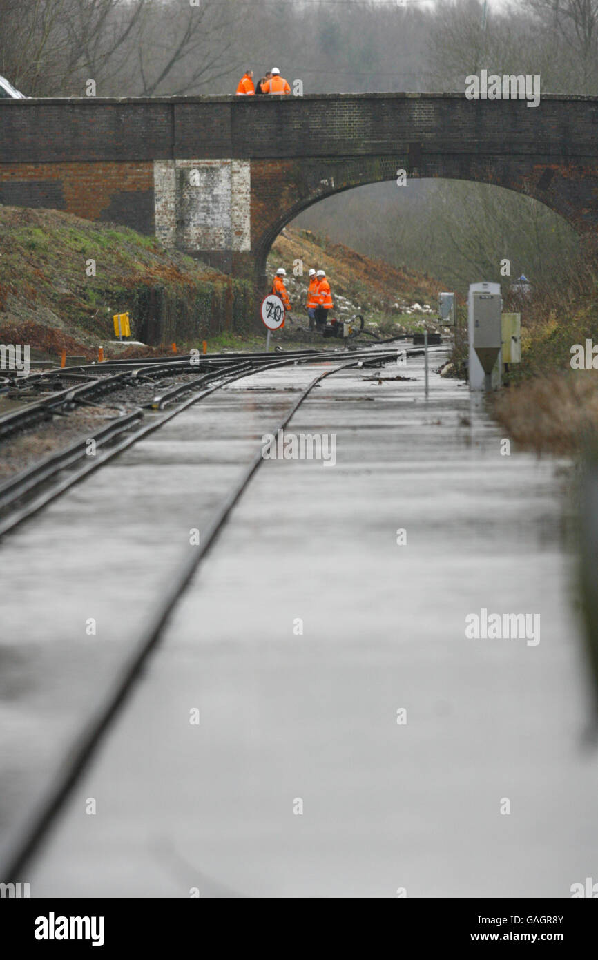 Engineers look at the railway line near Botley station in Hampshire ...
