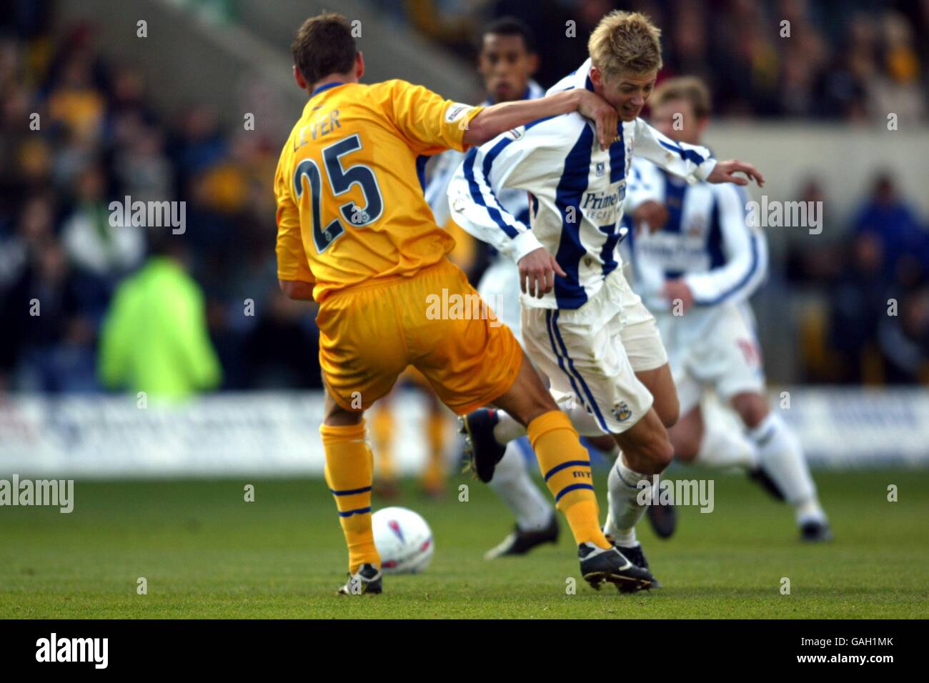 Mansfield Town's Mark Lever and Huddersfield Town's Jon Stead battle ...