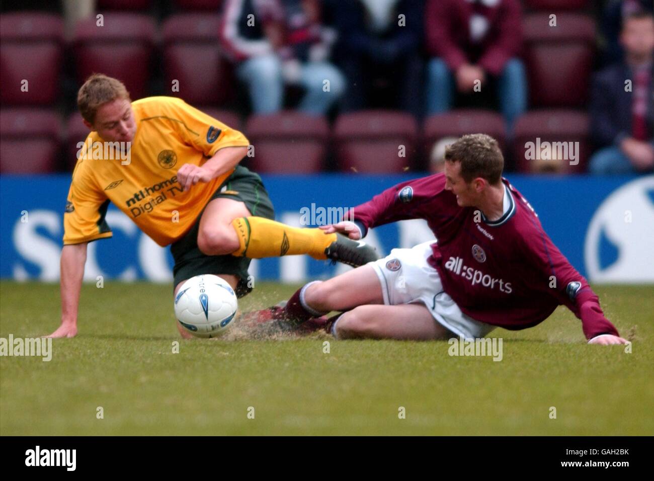 l-r; Celtic's Steve Guppy is tackled by Heart's David McGeown Stock ...
