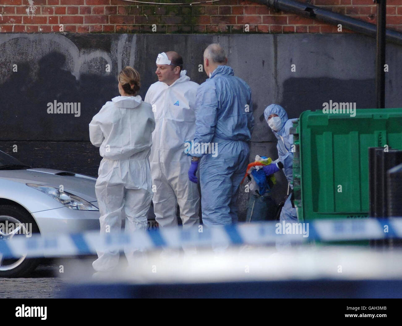 Police forensics officers attend the scene in Kilburn, north London ...