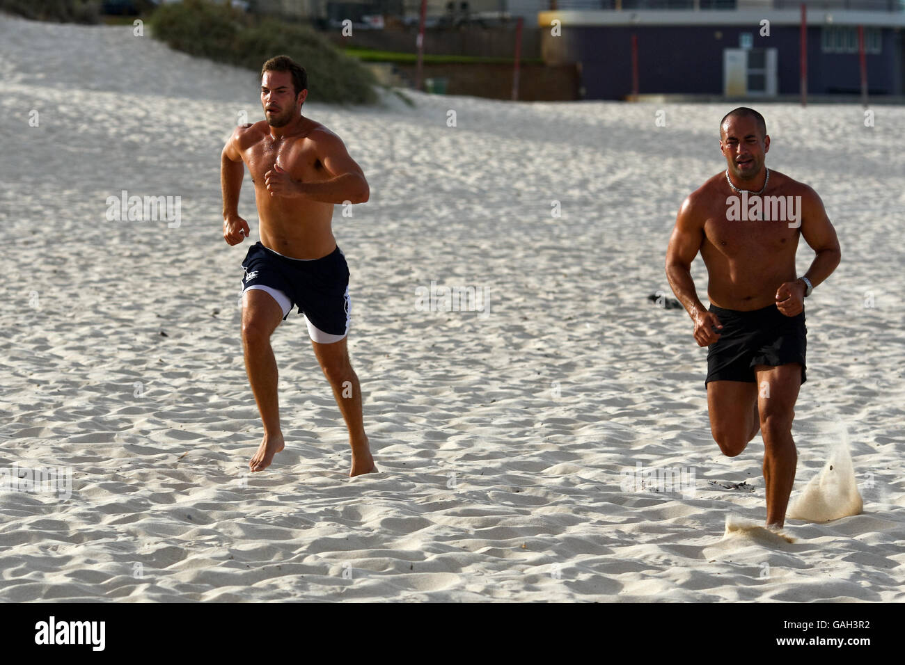 James Benning and Adam Hollioake excercise on the beach Stock Photo - Alamy