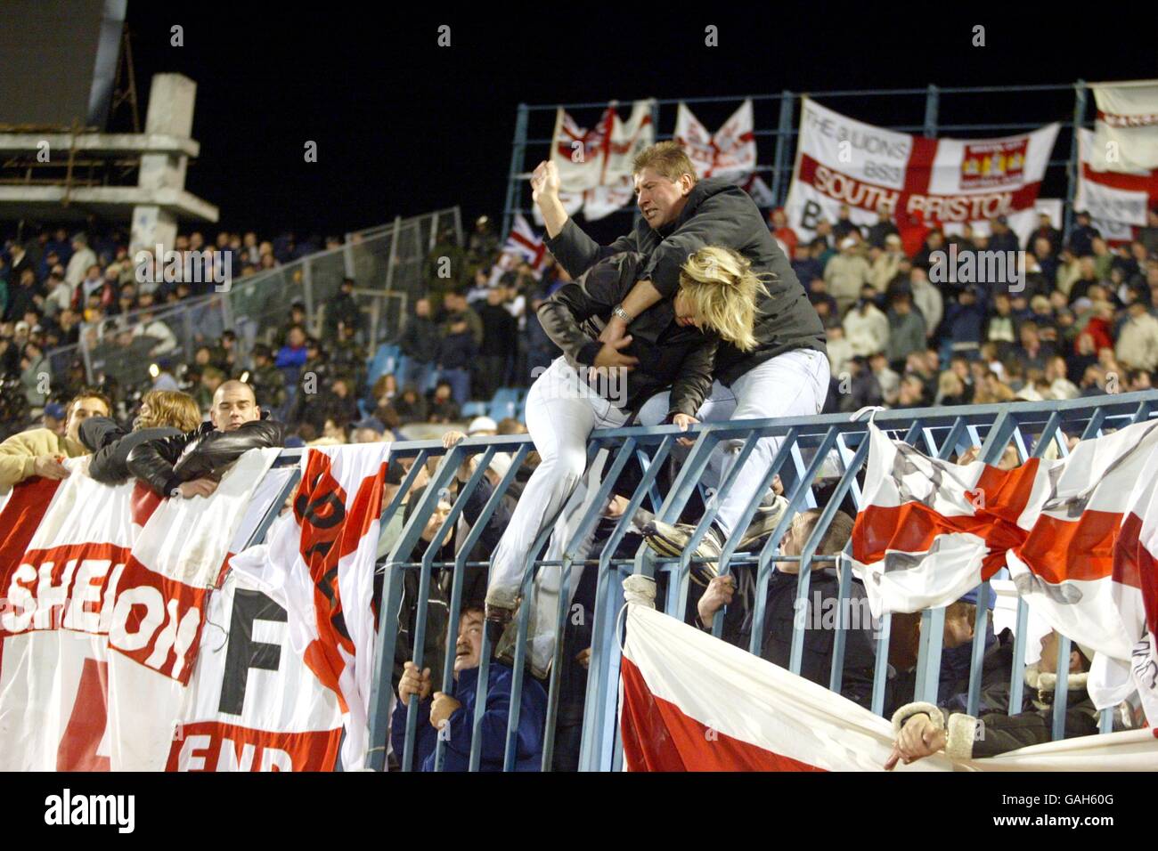 A female England fan is helped to safety after the Slovakian police ...