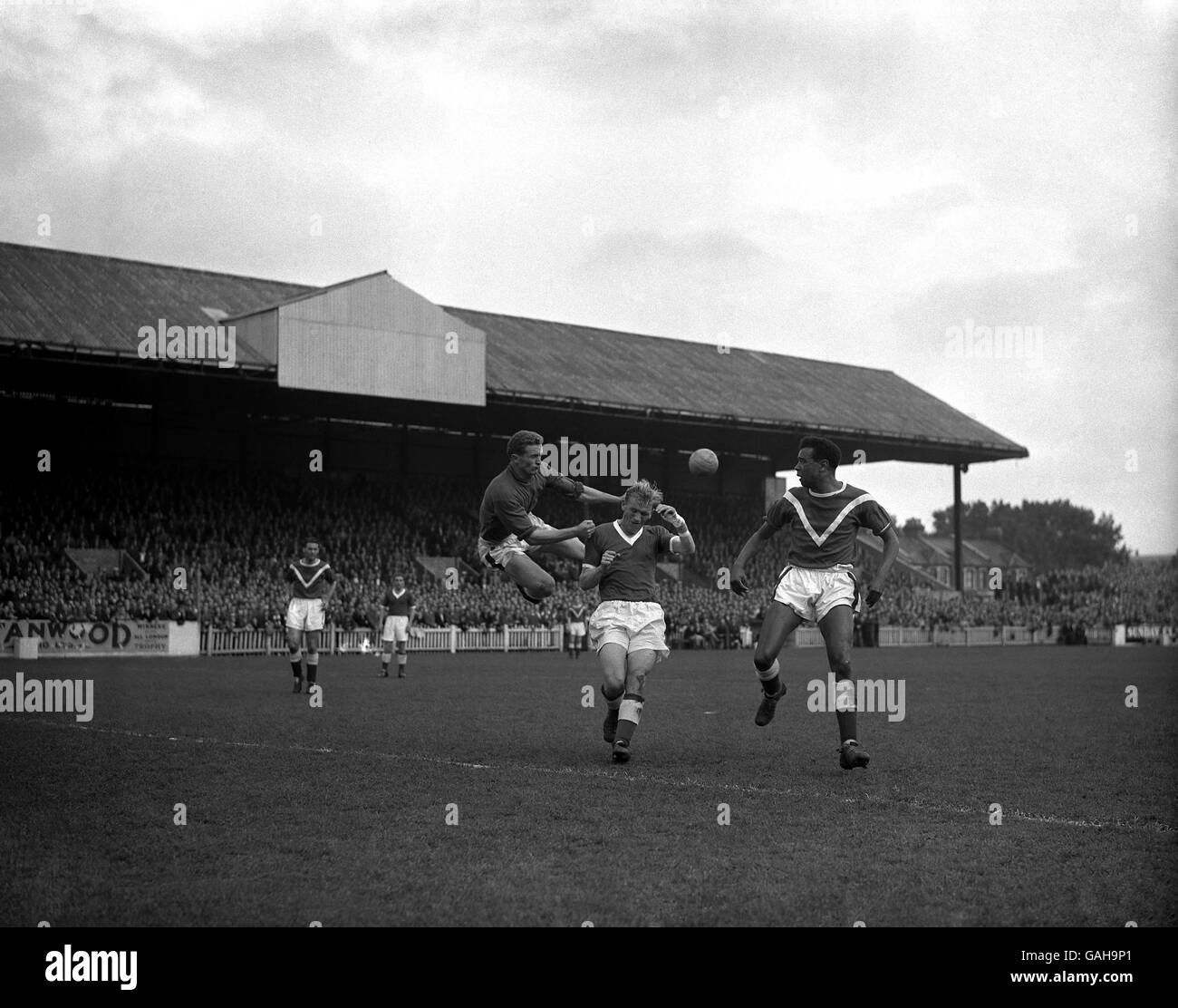 Harry Gregg, the Doncaster goalkeeper, left, Tom Johnston of Leyton ...