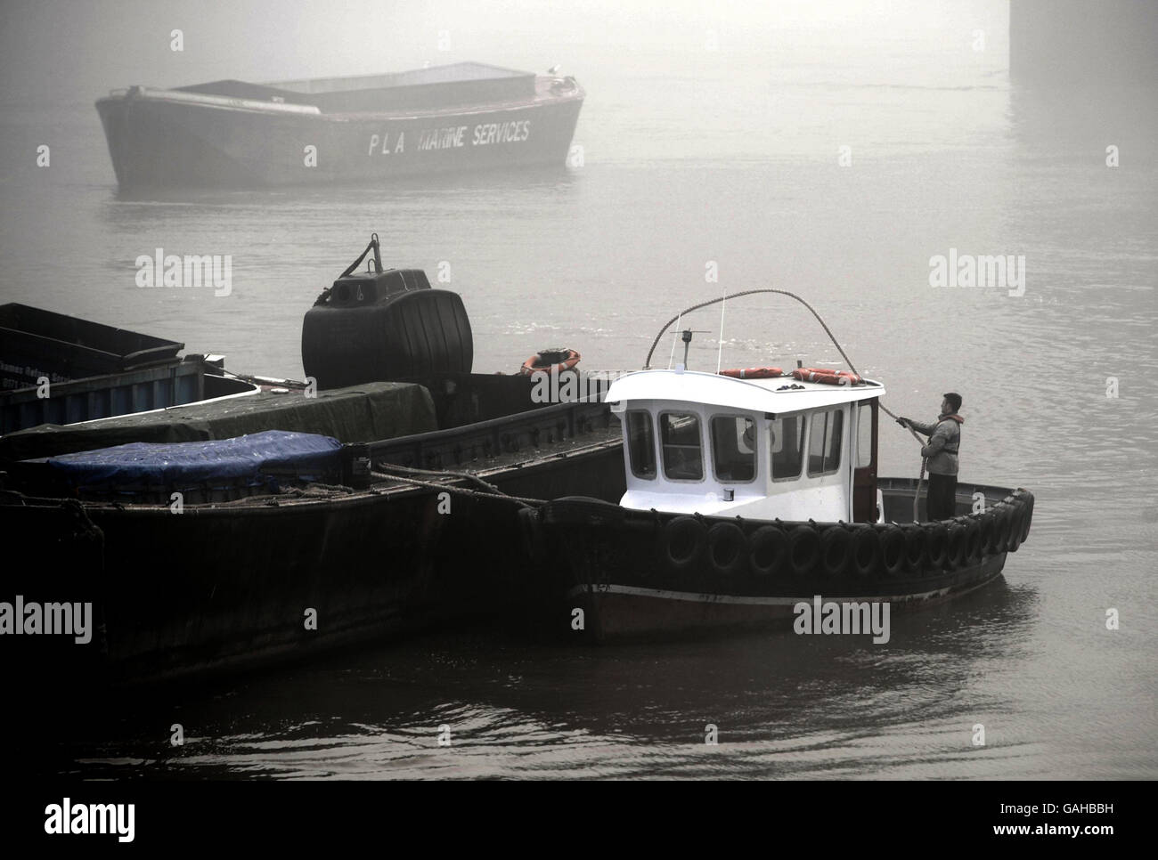 A river boatman works on the Thames, near the South Bank in the early ...