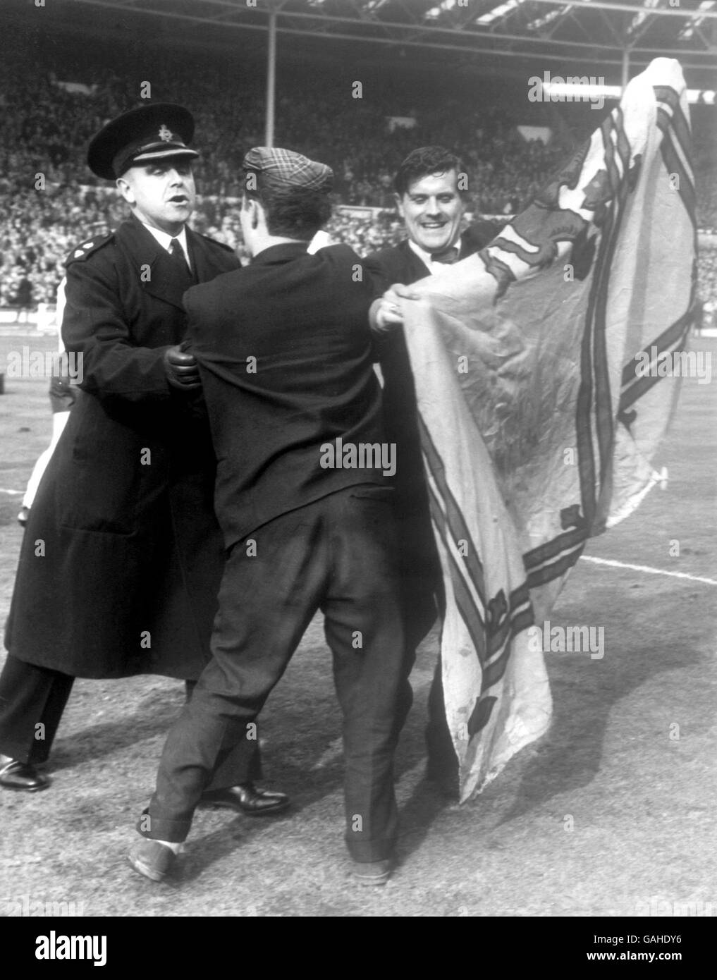 Two jubilant Scotland fans are accosted by a police inspector as they ...