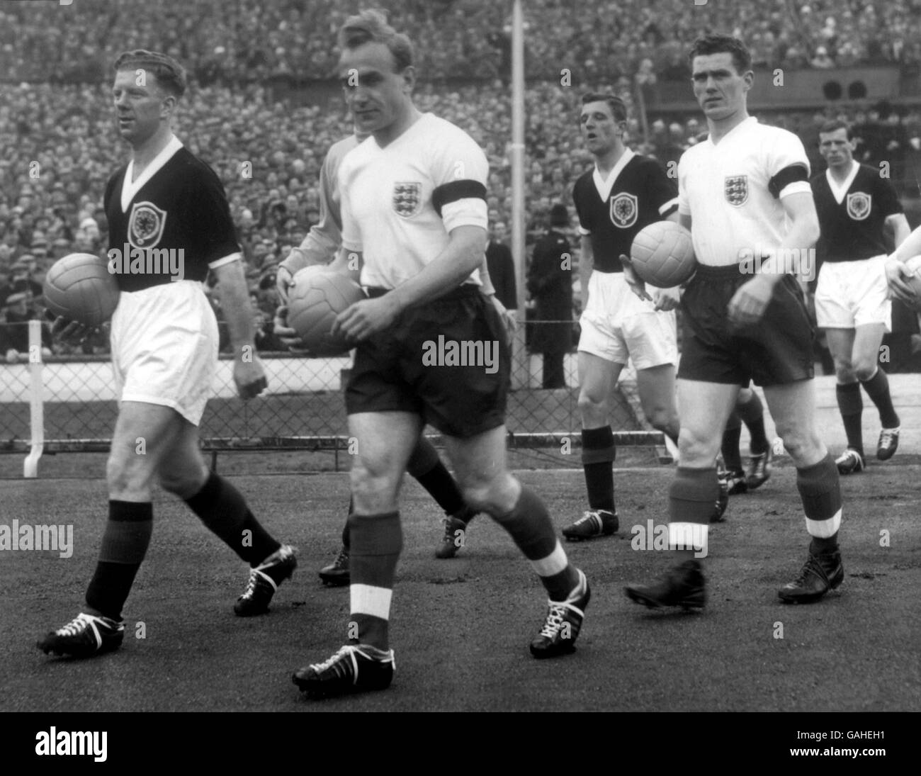 England's Billy Wright (second l) leads his team out before his 100th ...