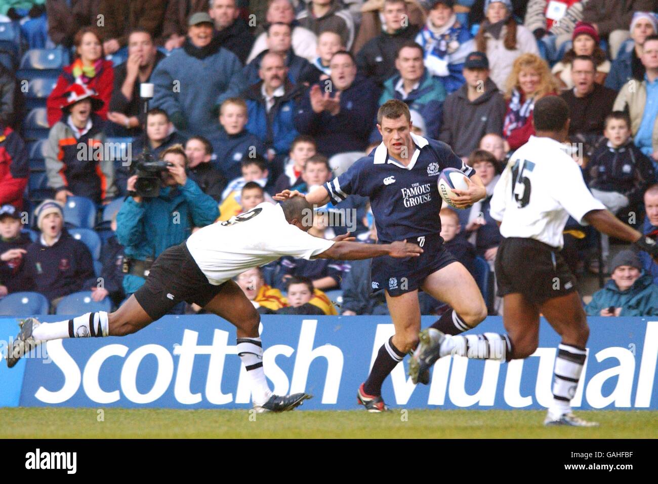Fiji's Jacob Rauluni (l) attempts to tackle Scotland's Ben Hinshelwood ...