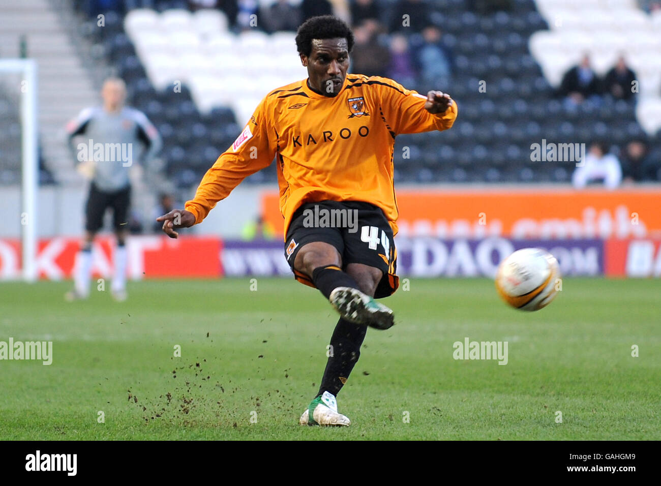 Hull City's Jay-Jay Okocha sweeps a free kick into the box where an ...