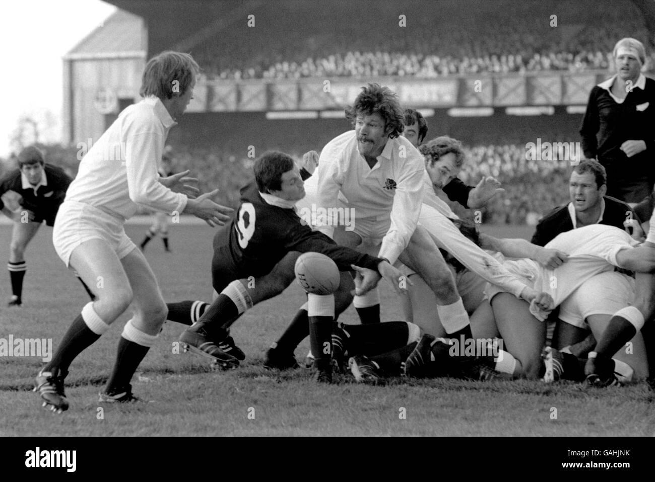 England flanker Peter Dixon (r) lays the ball off to teammate Malcolm ...