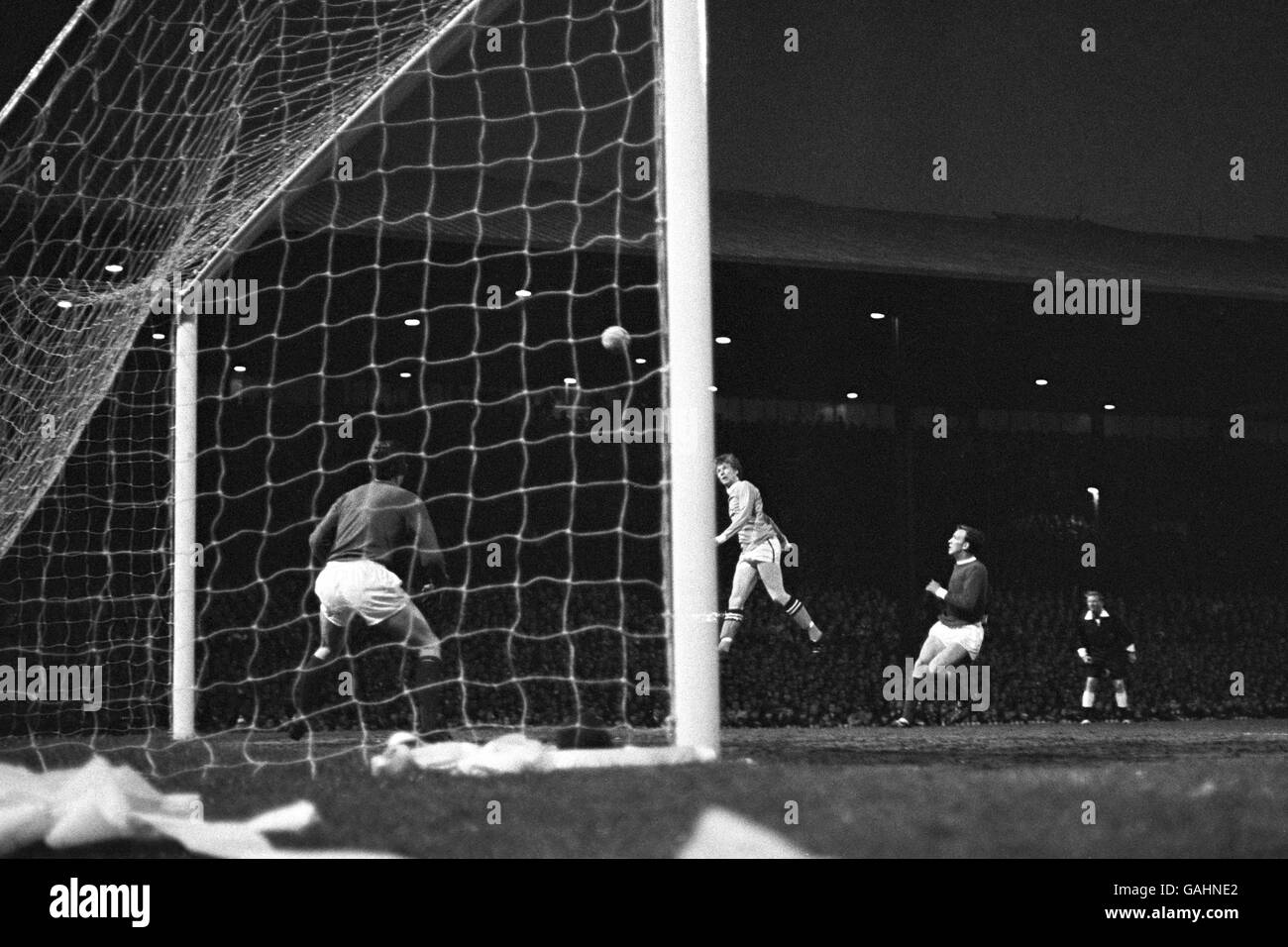 Colin Bell of Manchester City goes high in the air as he heads the ball ...