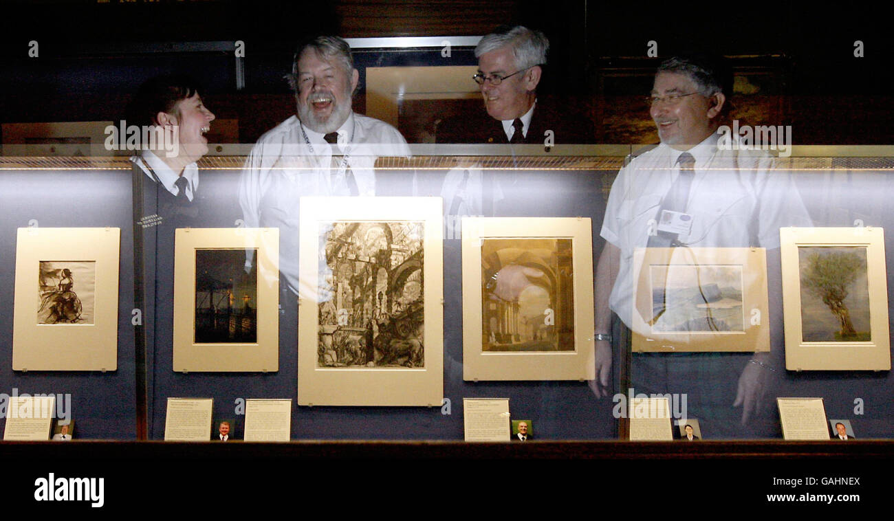Gallery wardens are seen reflected in a glass cabinet at the new Warders' Choice exhibition at ...