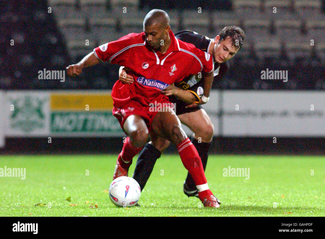 Swindon towns eric sabin holds off notts countys danny stone hi-res ...