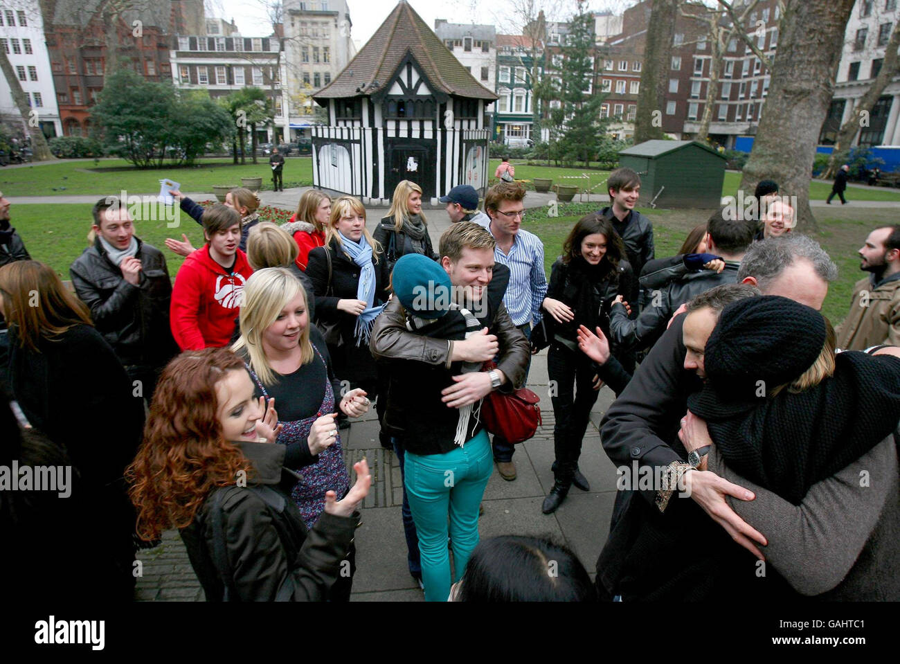 A crowd of strangers embrace in soho square hi-res stock photography ...
