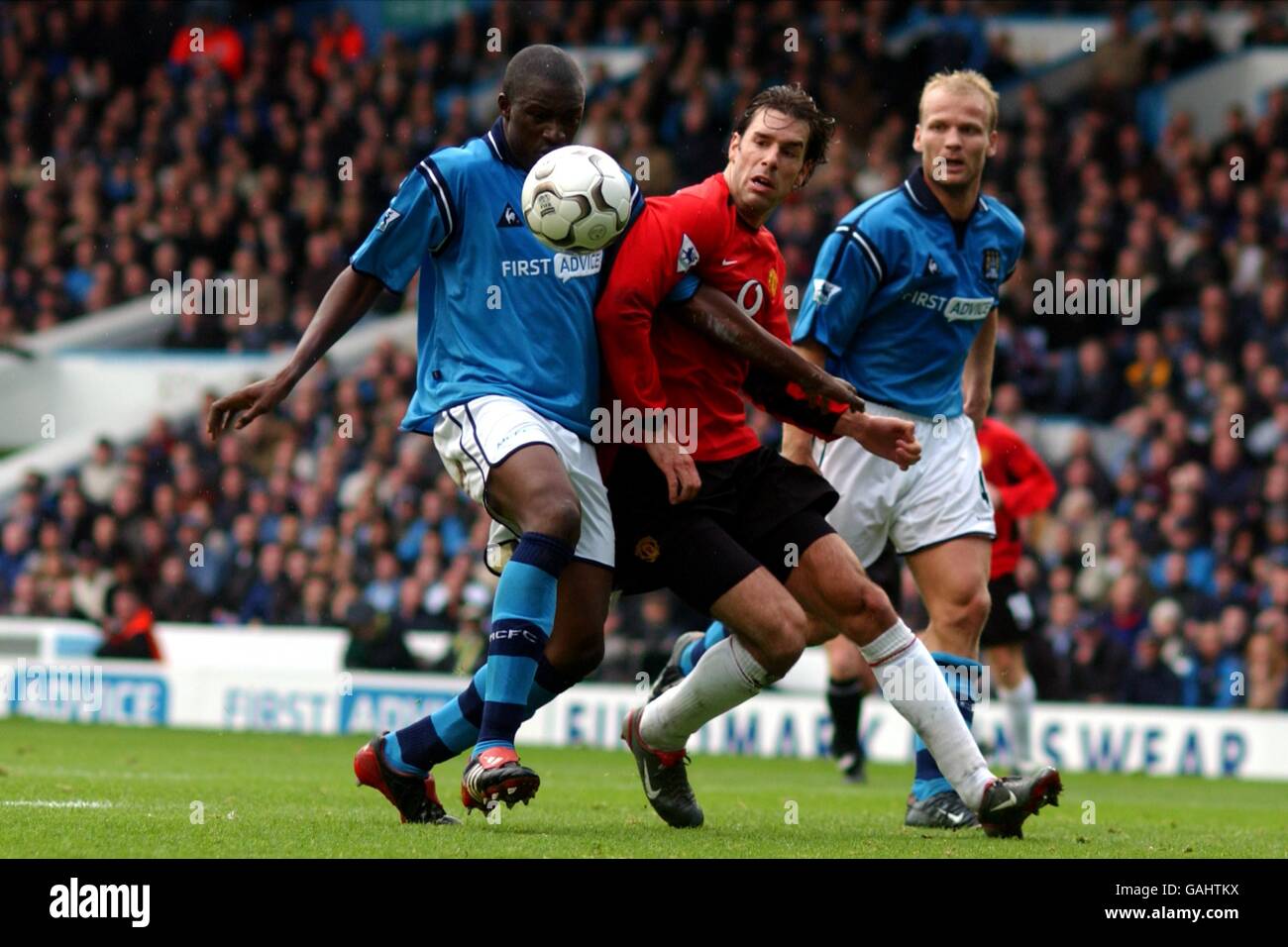 Manchester City's Lucien Mettomo holds off Manchester United's Ruud Van ...