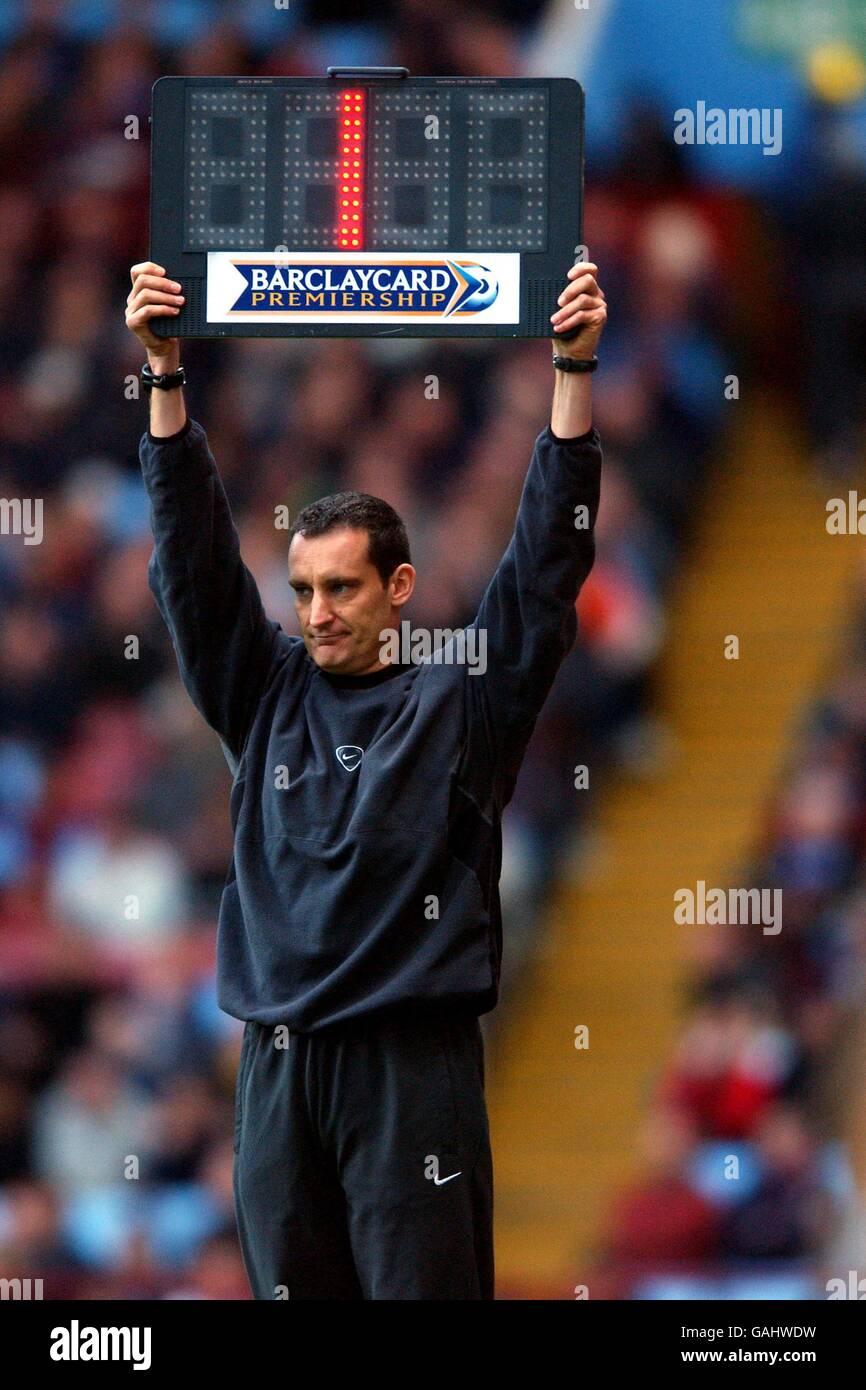 The fourth official signals one minute of added time hi-res stock ...
