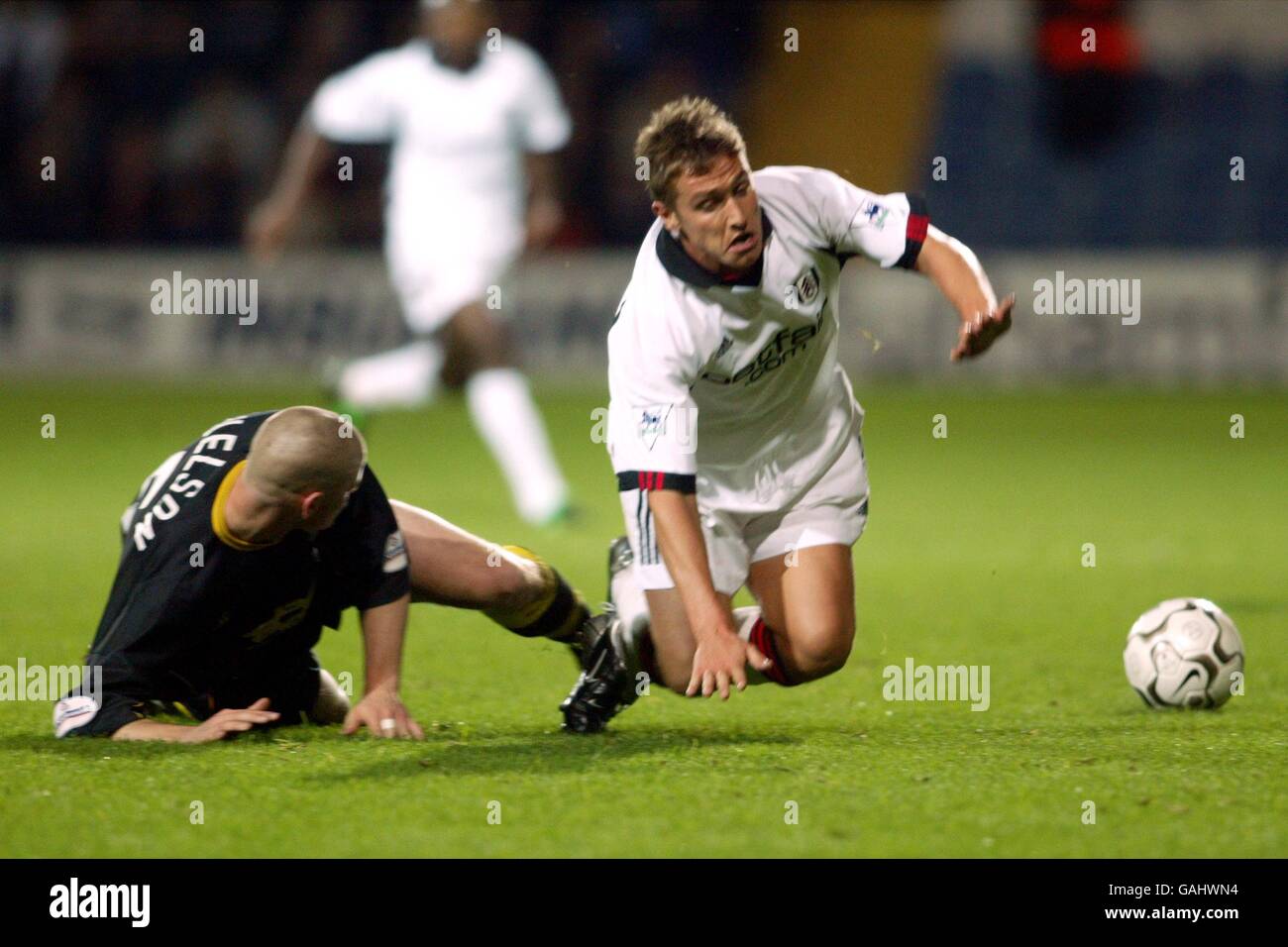 Fulham's Lee Clark (r) is brought down by Bury's Michael Nelson (l ...