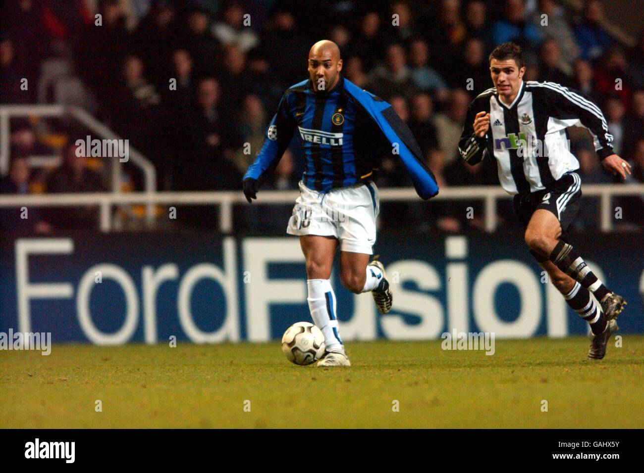 Inter milans stephane dalmat goes past newcastle uniteds aaron hughes ...