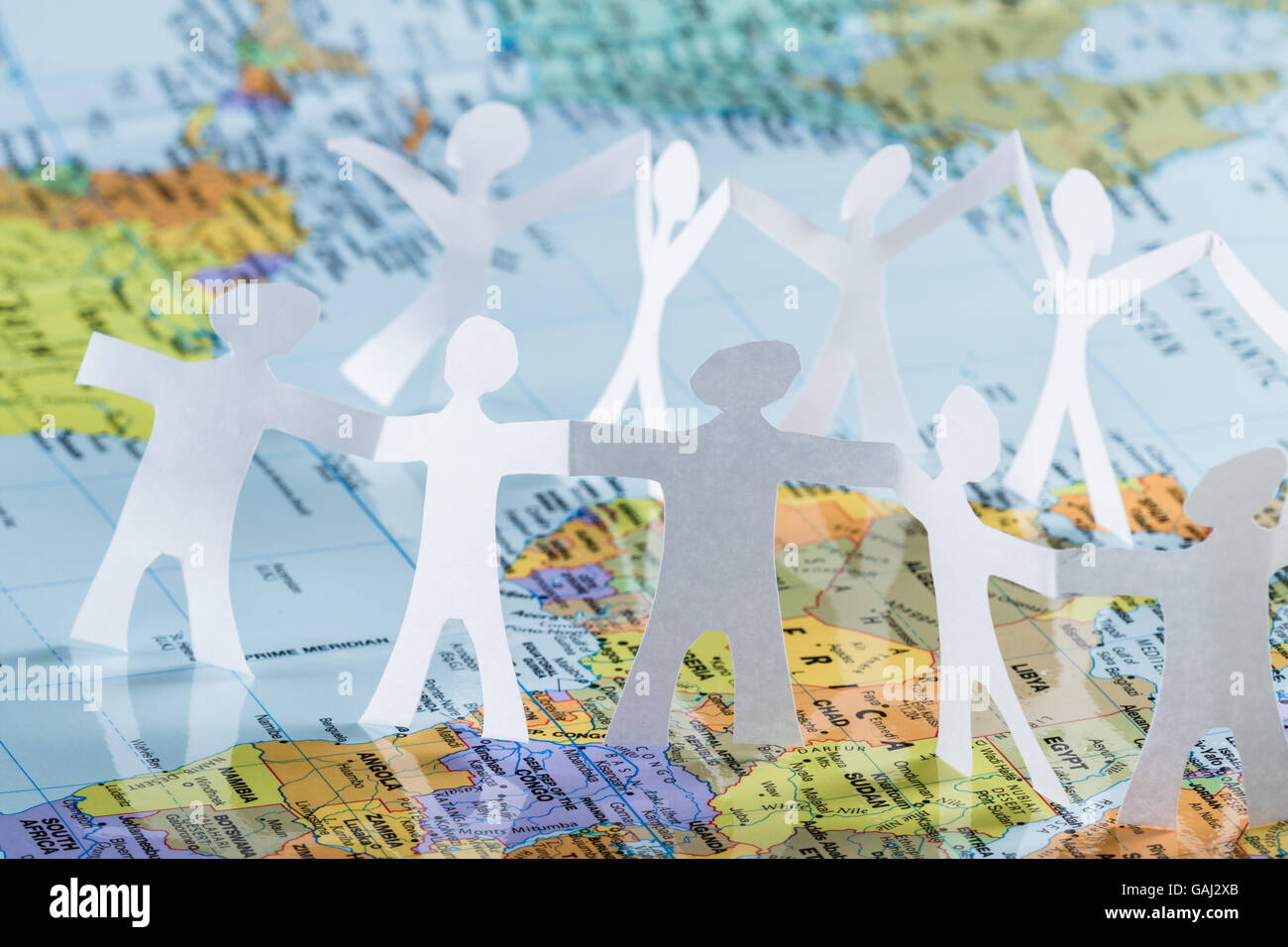 concept image using paper people holding hands using a world map as a ...