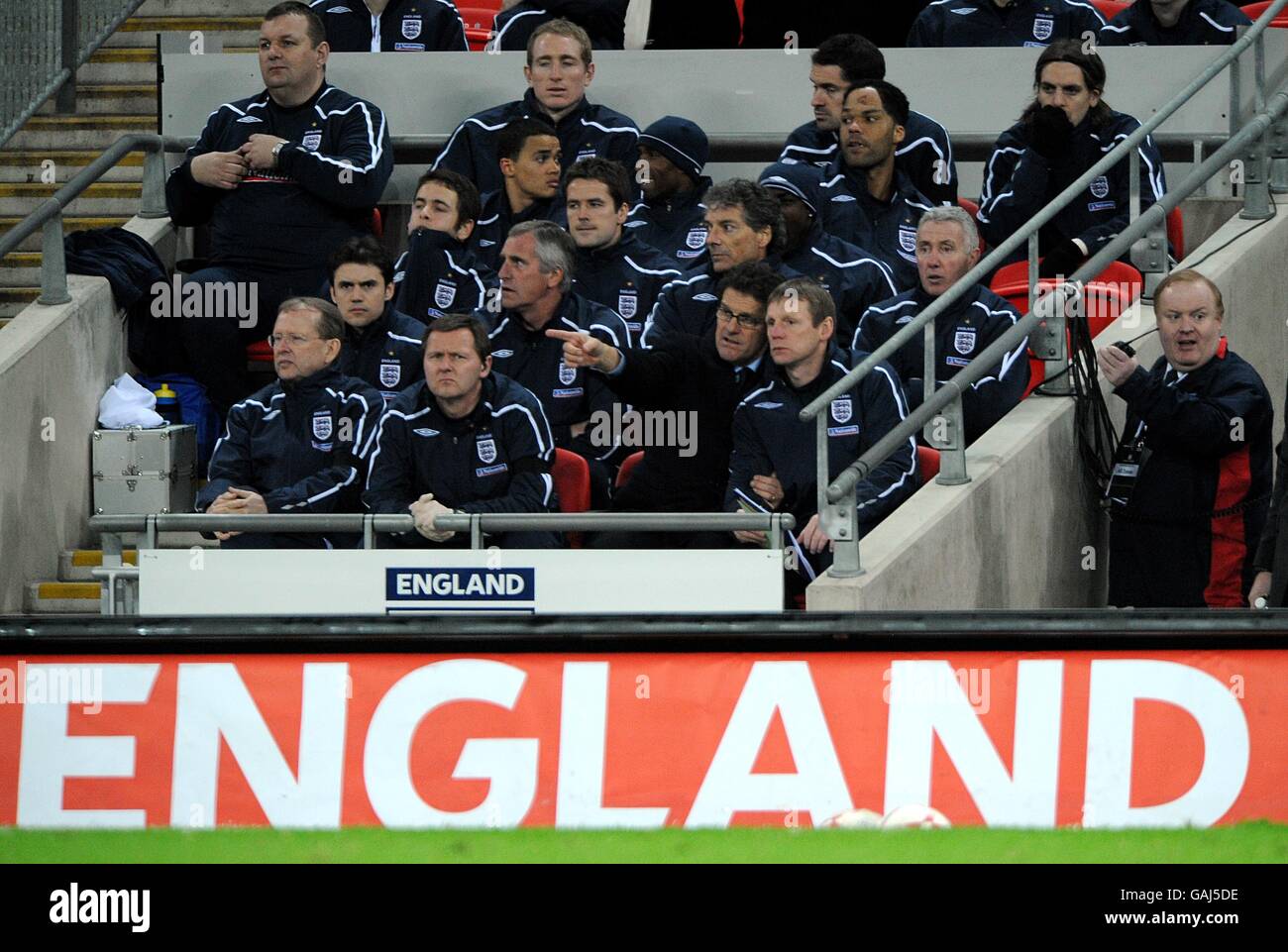 England manager Fabio Capello and coach Stuart Pearce look on from the ...