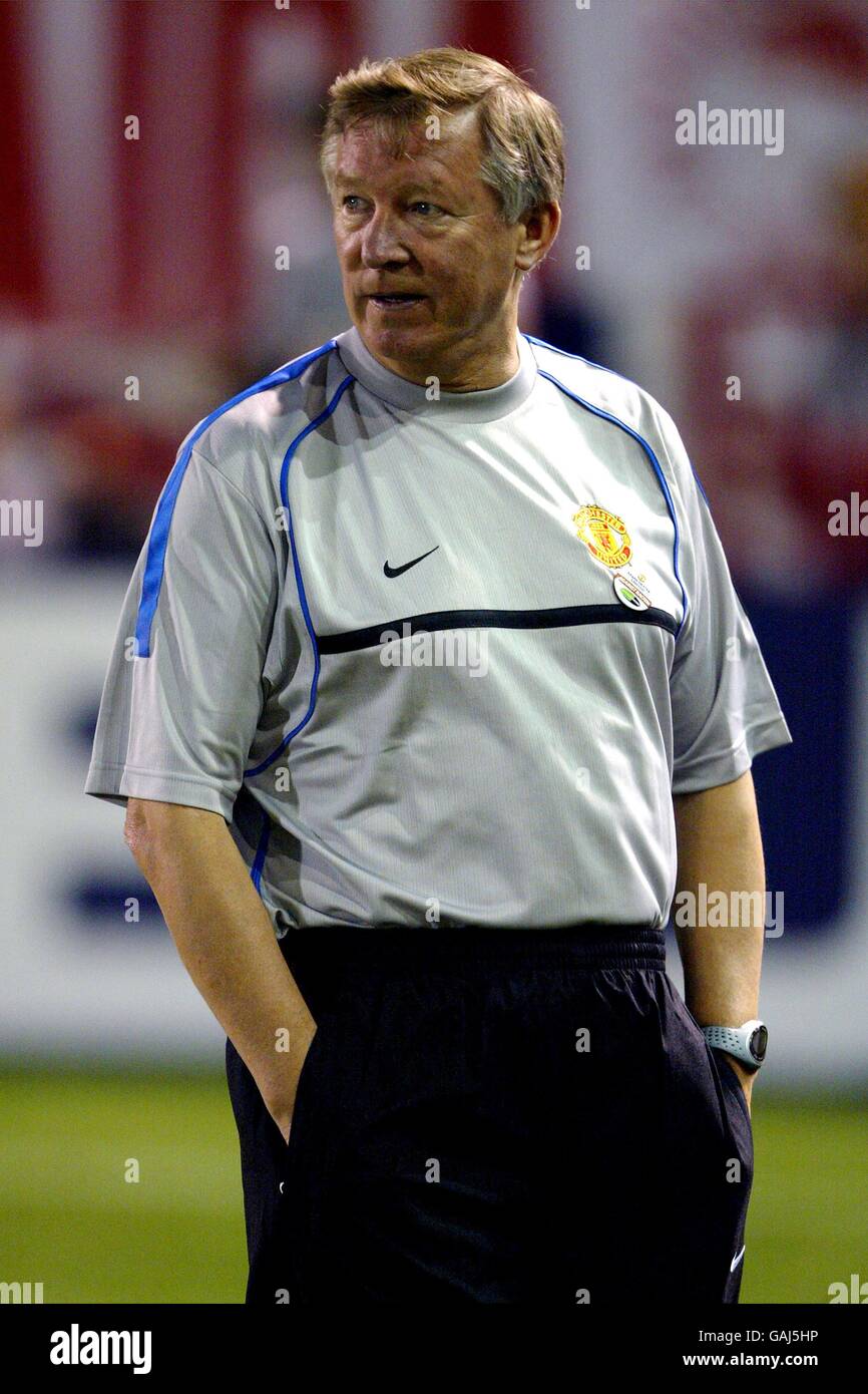Manchester uniteds manager alex ferguson watches from the bench hi-res ...