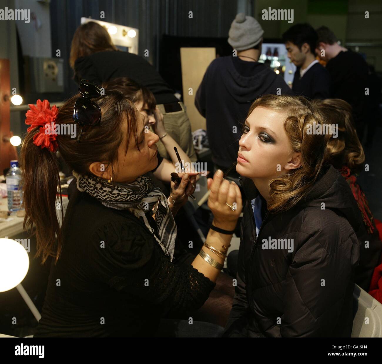 Scenes from the back stage area of the show by designer Ashley Isham ...